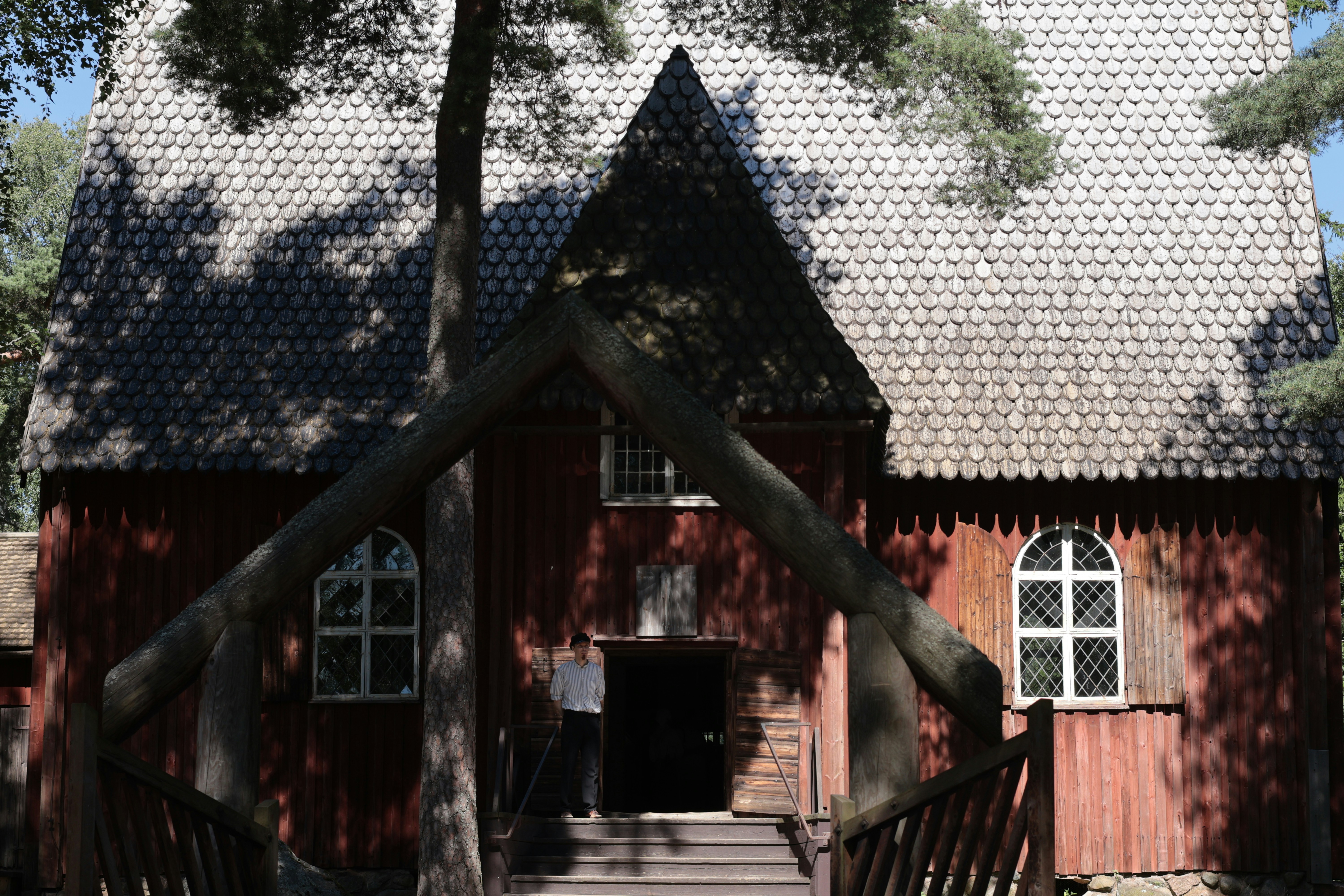 A Quiet Facade: Red Barn Through a Framed Arch