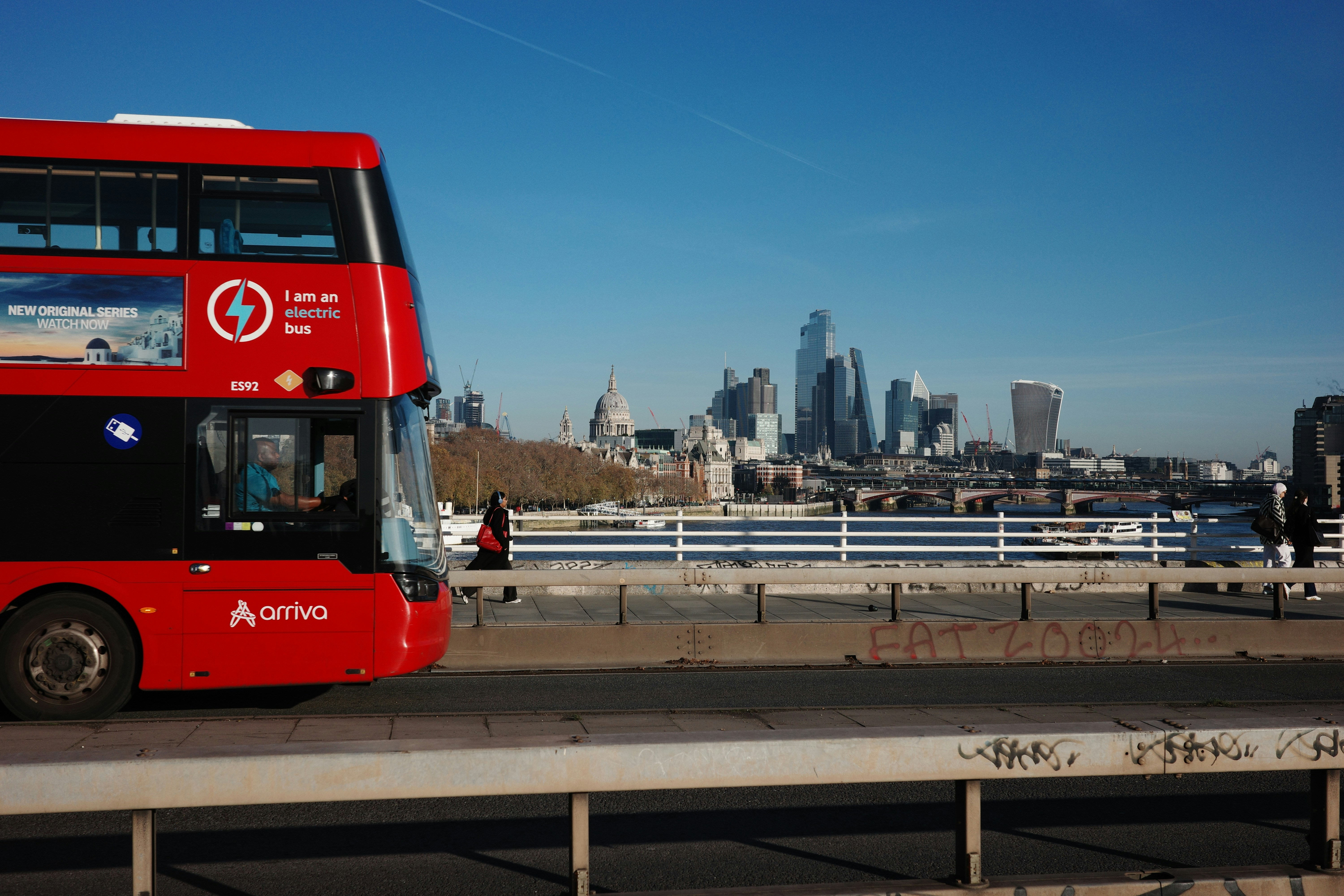 London Bus on the Thames Front with City Skyline