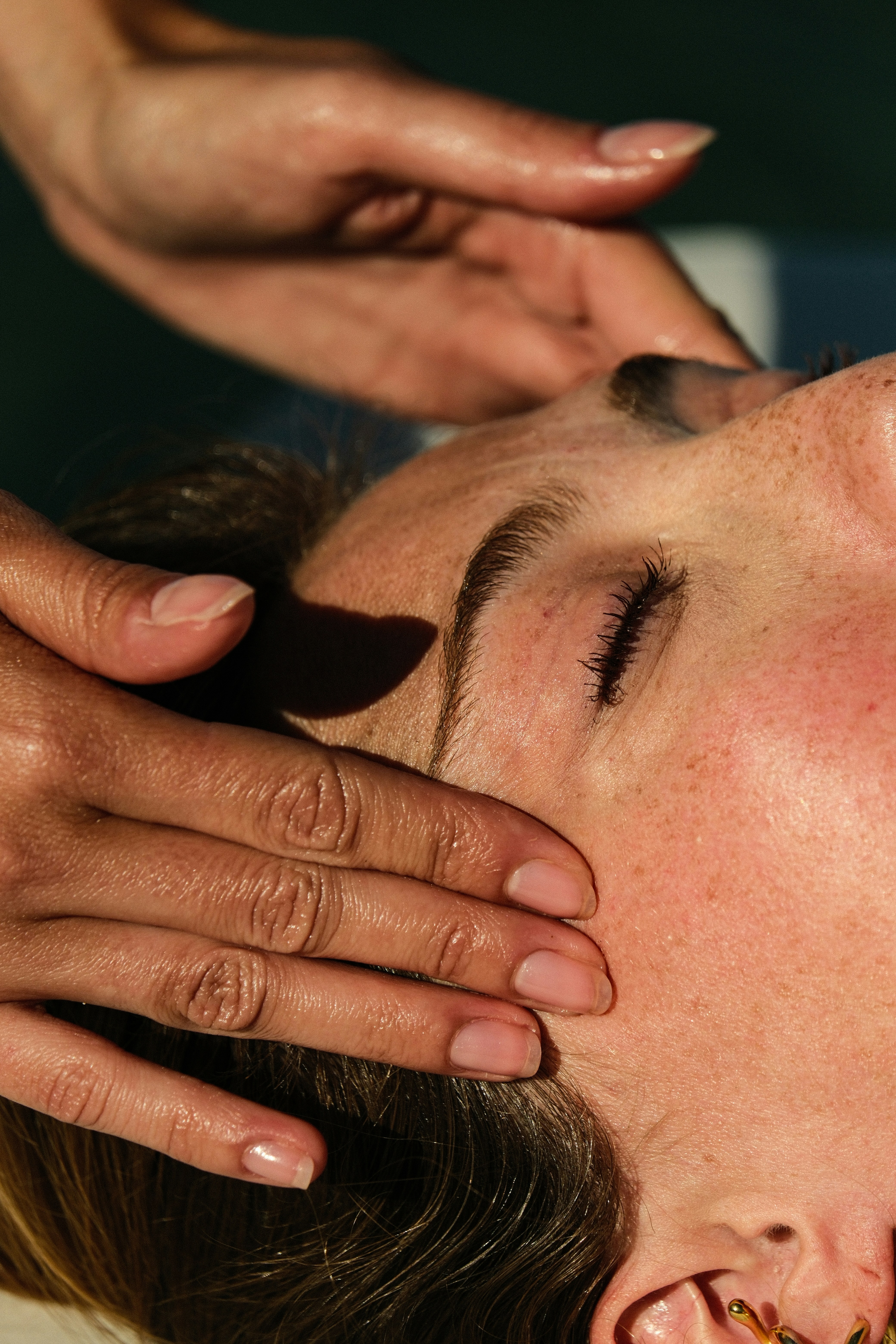 Hands of Calm: A Gentle Facial Touch during a Quiet Spa Moment