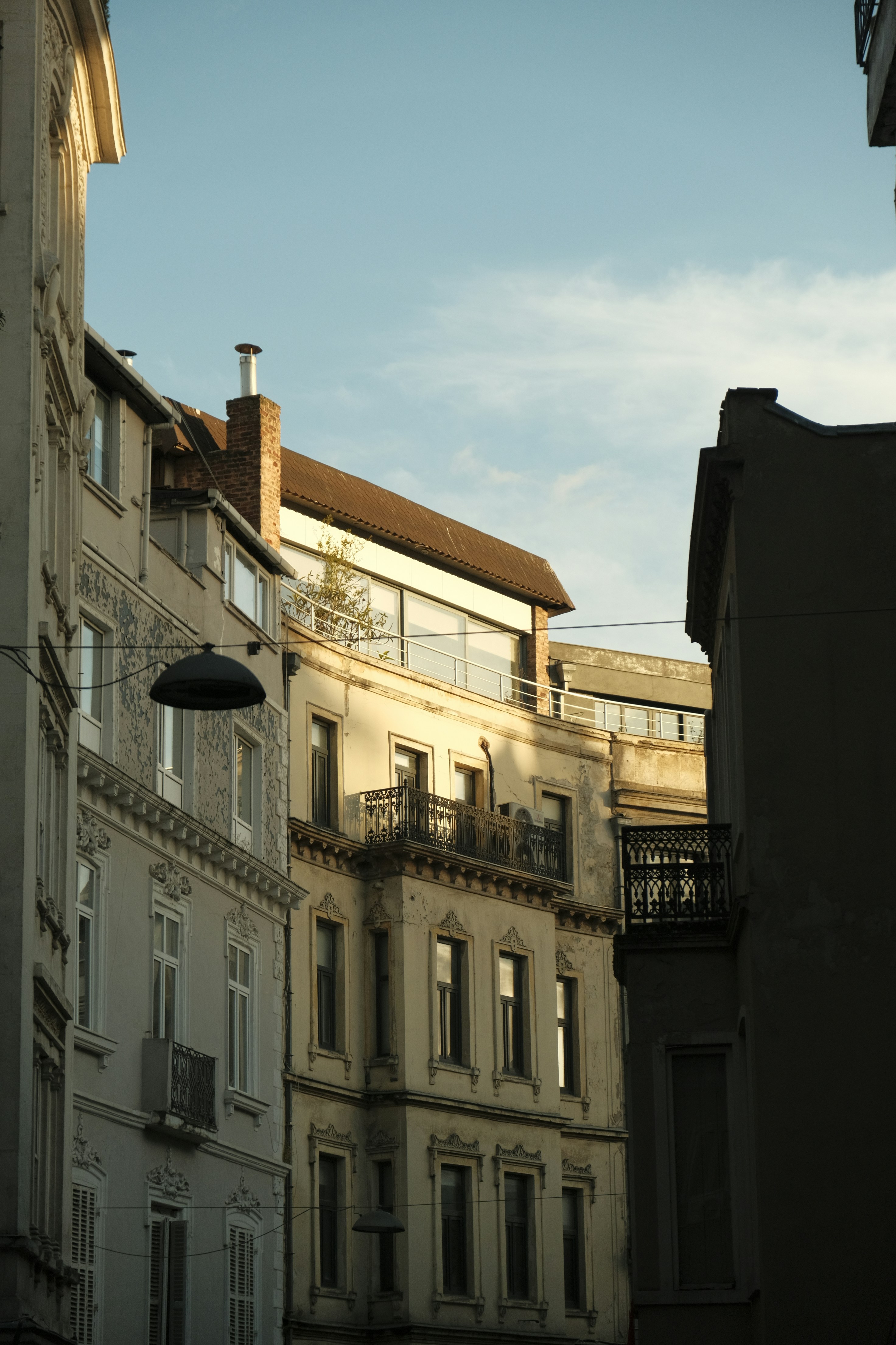 Sunlit Facades and Quiet Shadows in a Narrow European Street