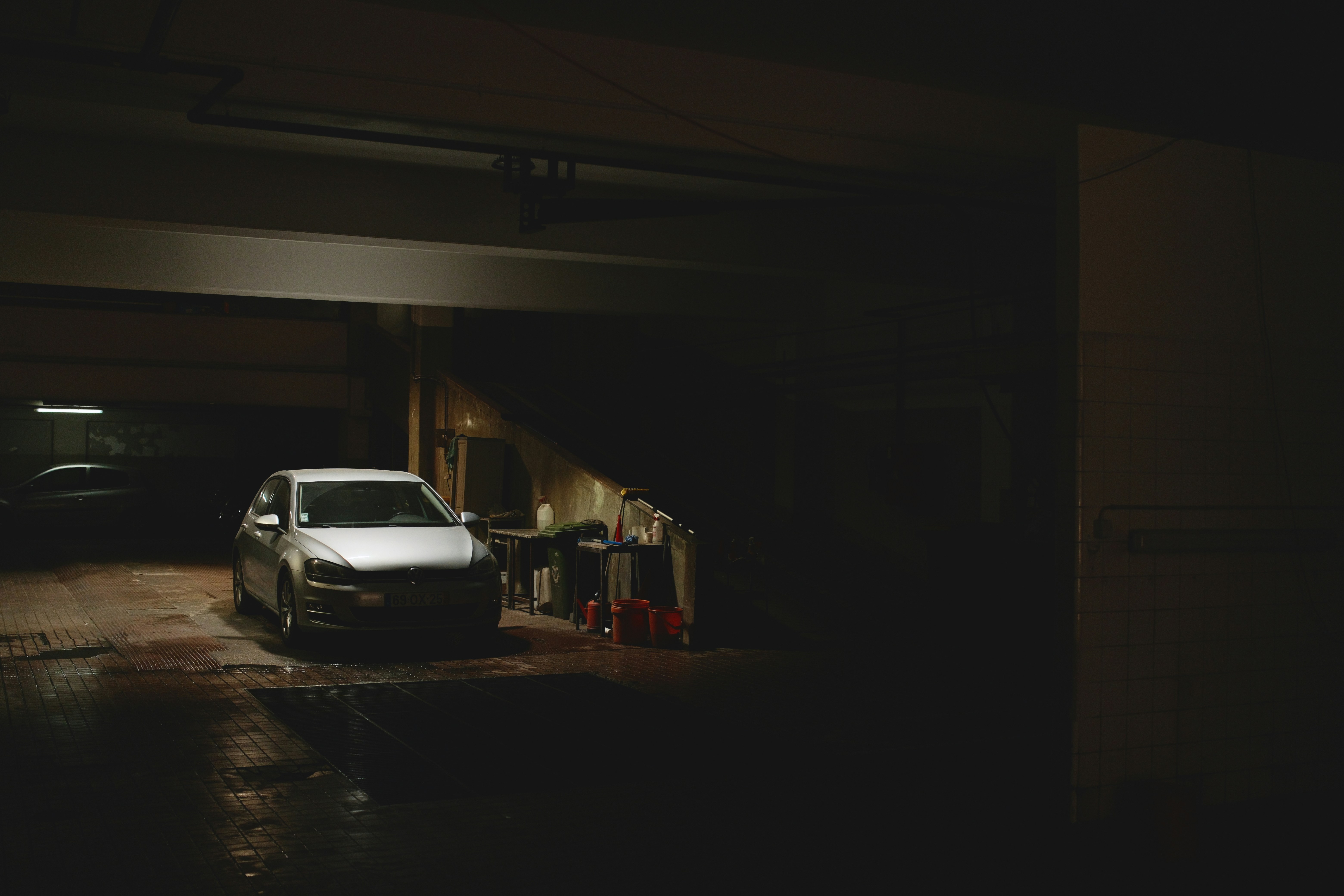 Quiet Carport: A Silver Sedan Emerges from the Shadows
