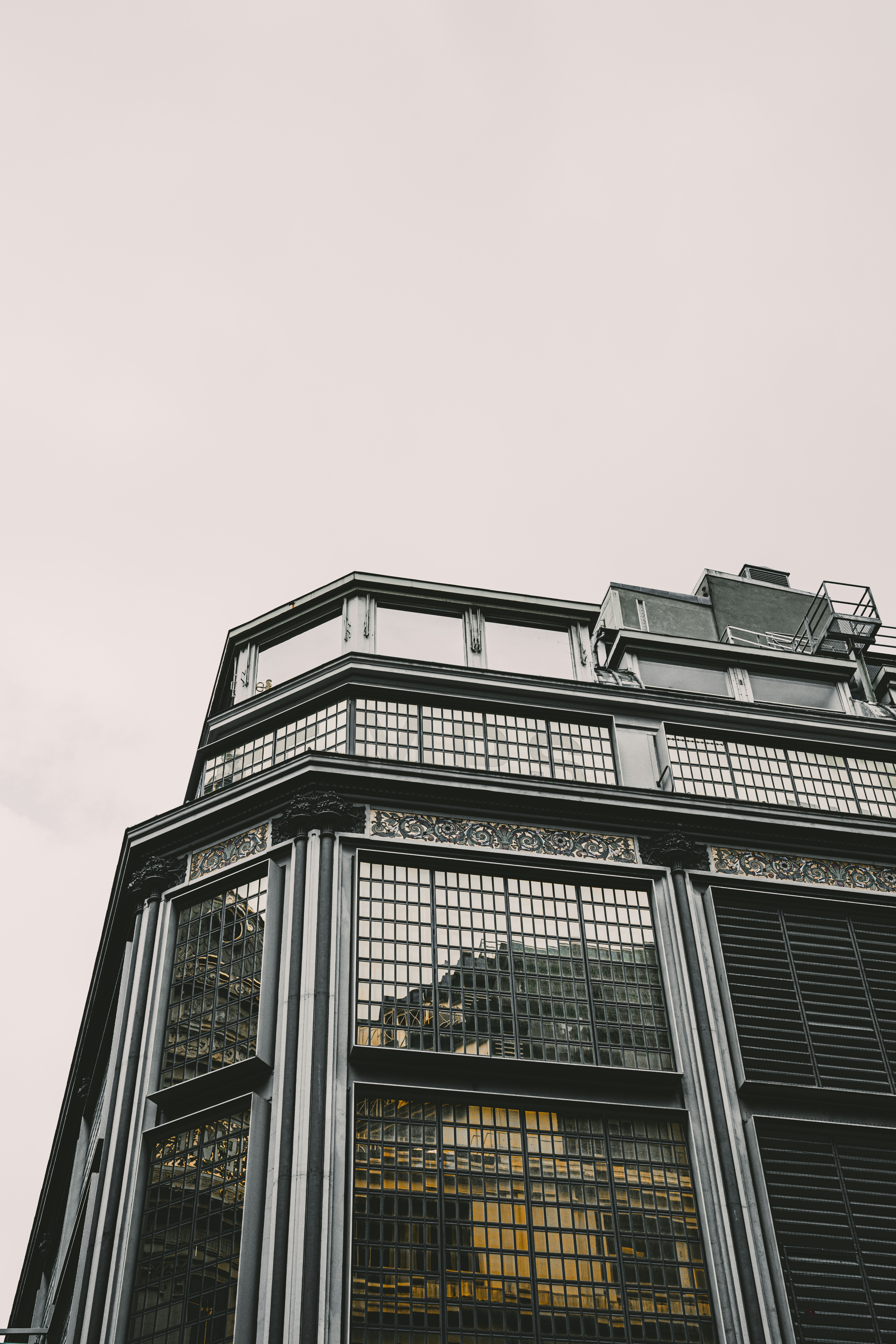 Urban Facade in Monochrome: Geometric Windows and Weathered Steel