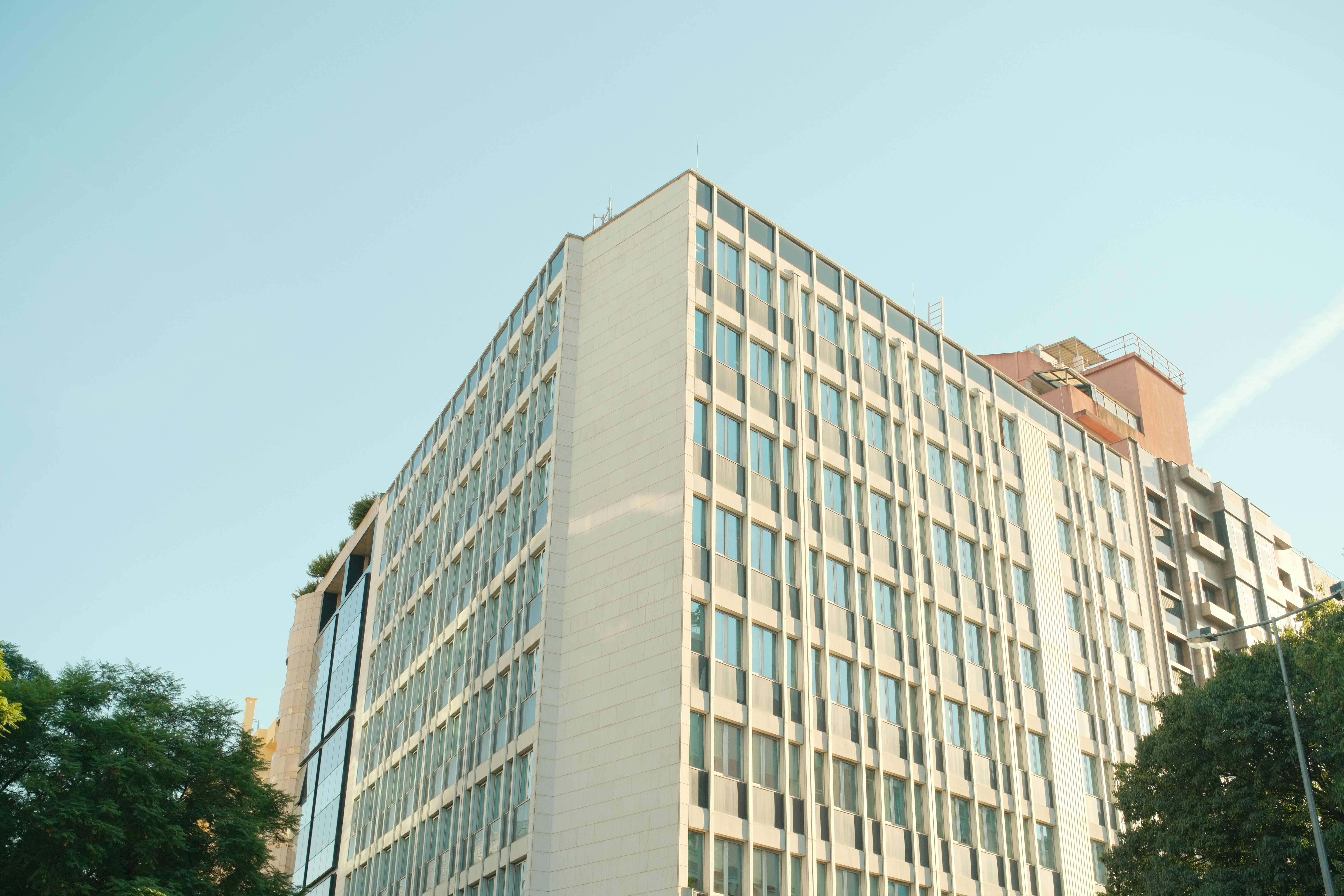 Vertical skyline: a sunlit office block under a clear blue sky