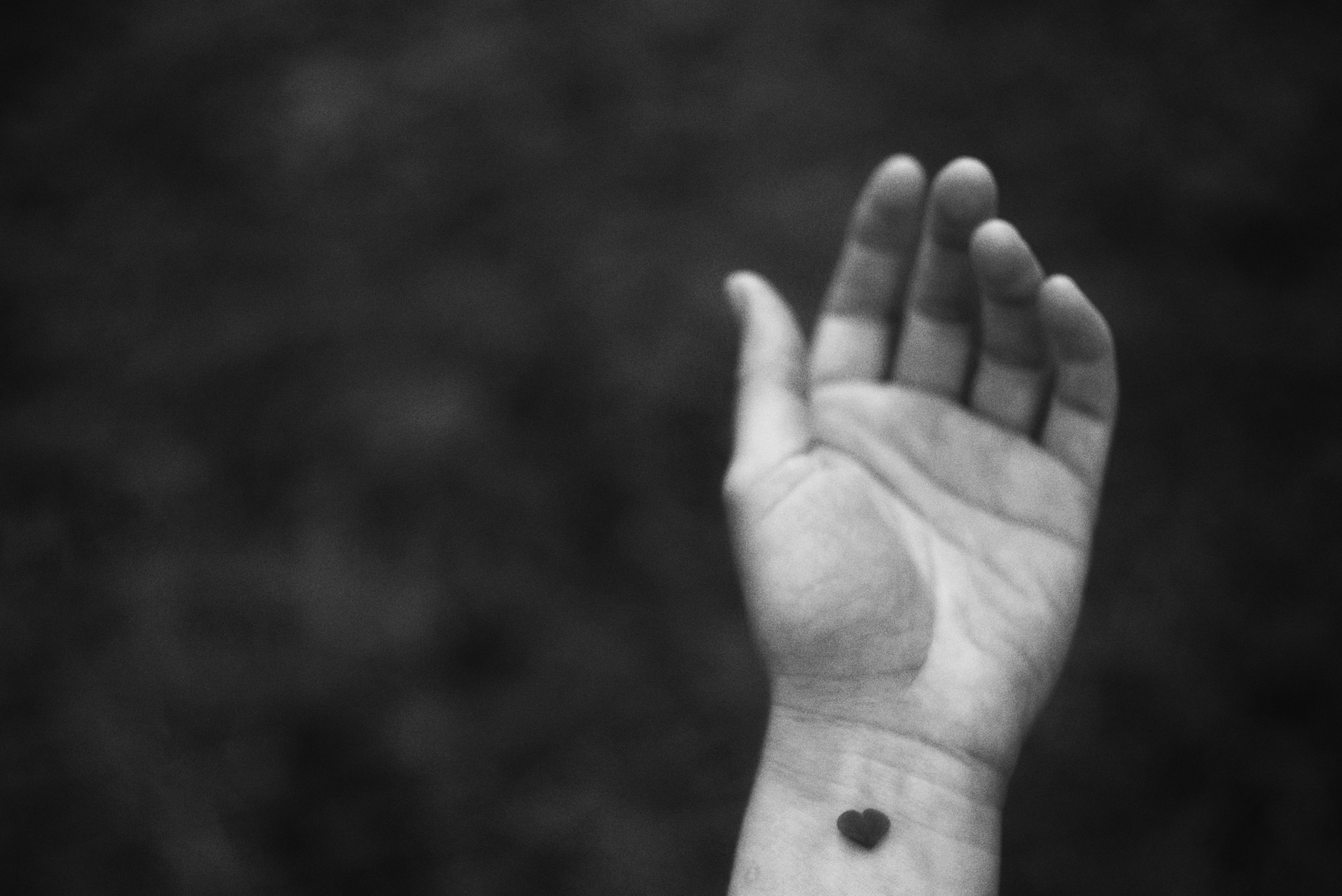 A Tiny Black Heart: A Palm-Side Tattoo as the Focal Point