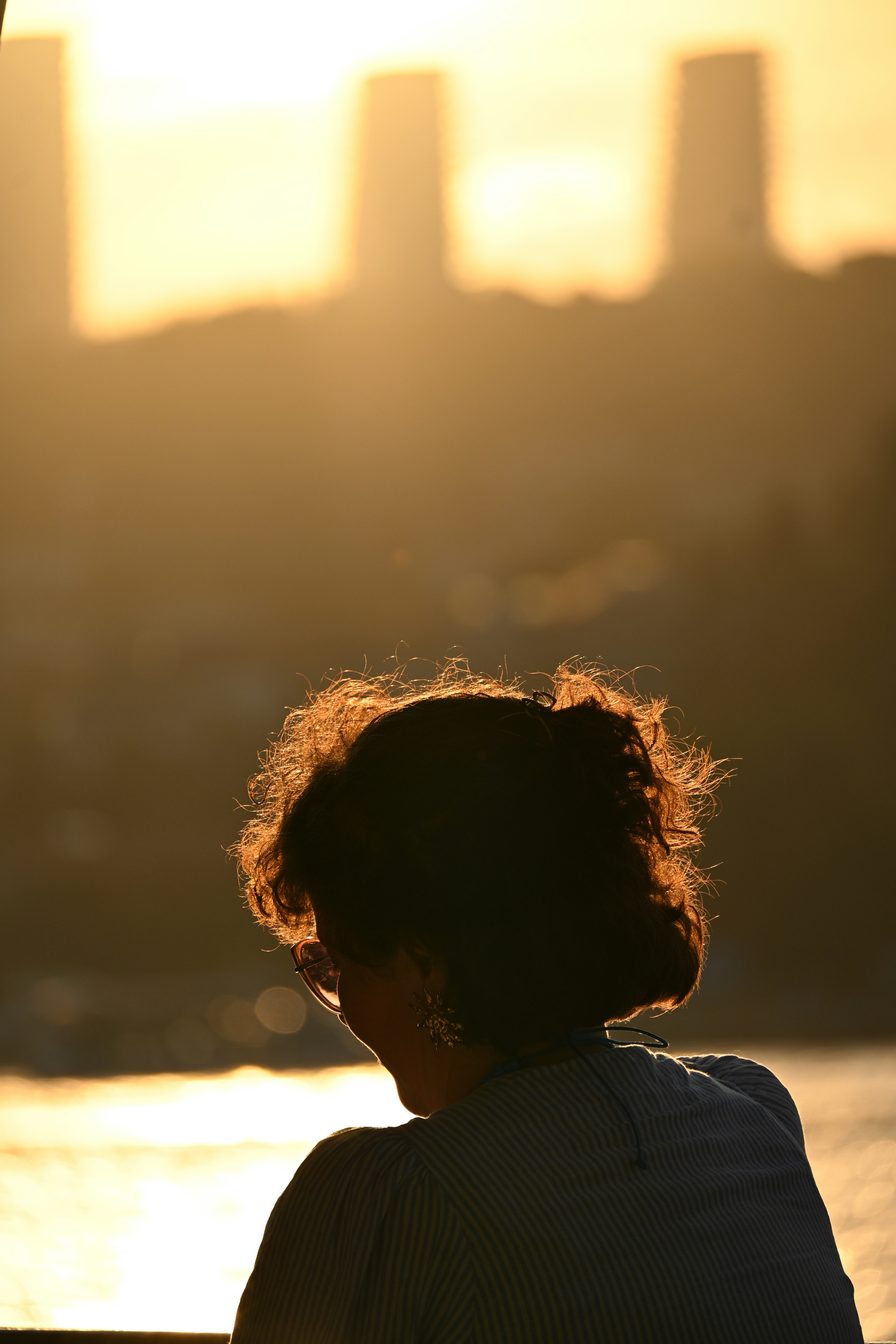 Golden Hour Silhouette: Portrait at the Waterfront