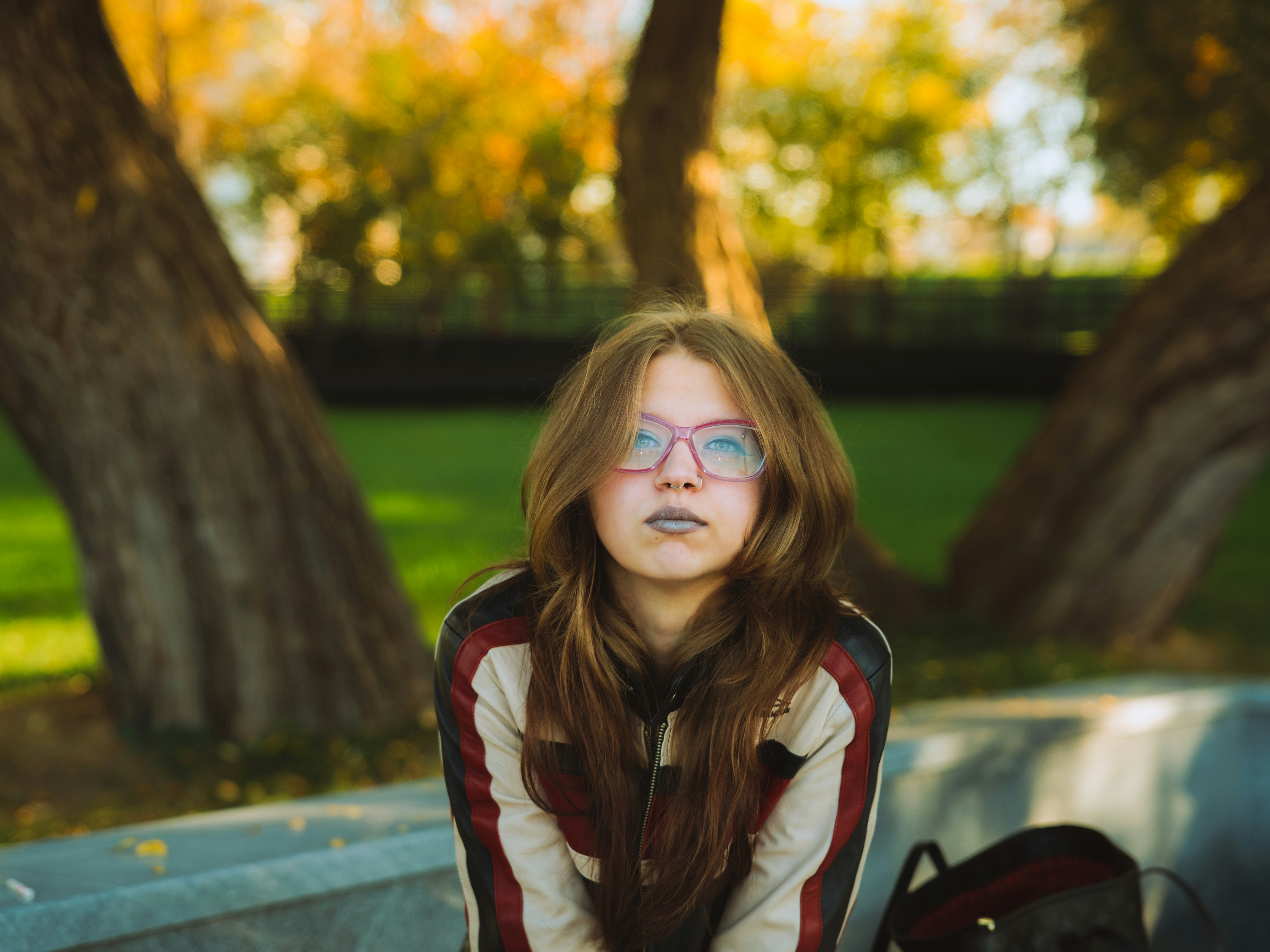 Portrait in Autumn Light: Centered Gaze Beneath Wary Trees