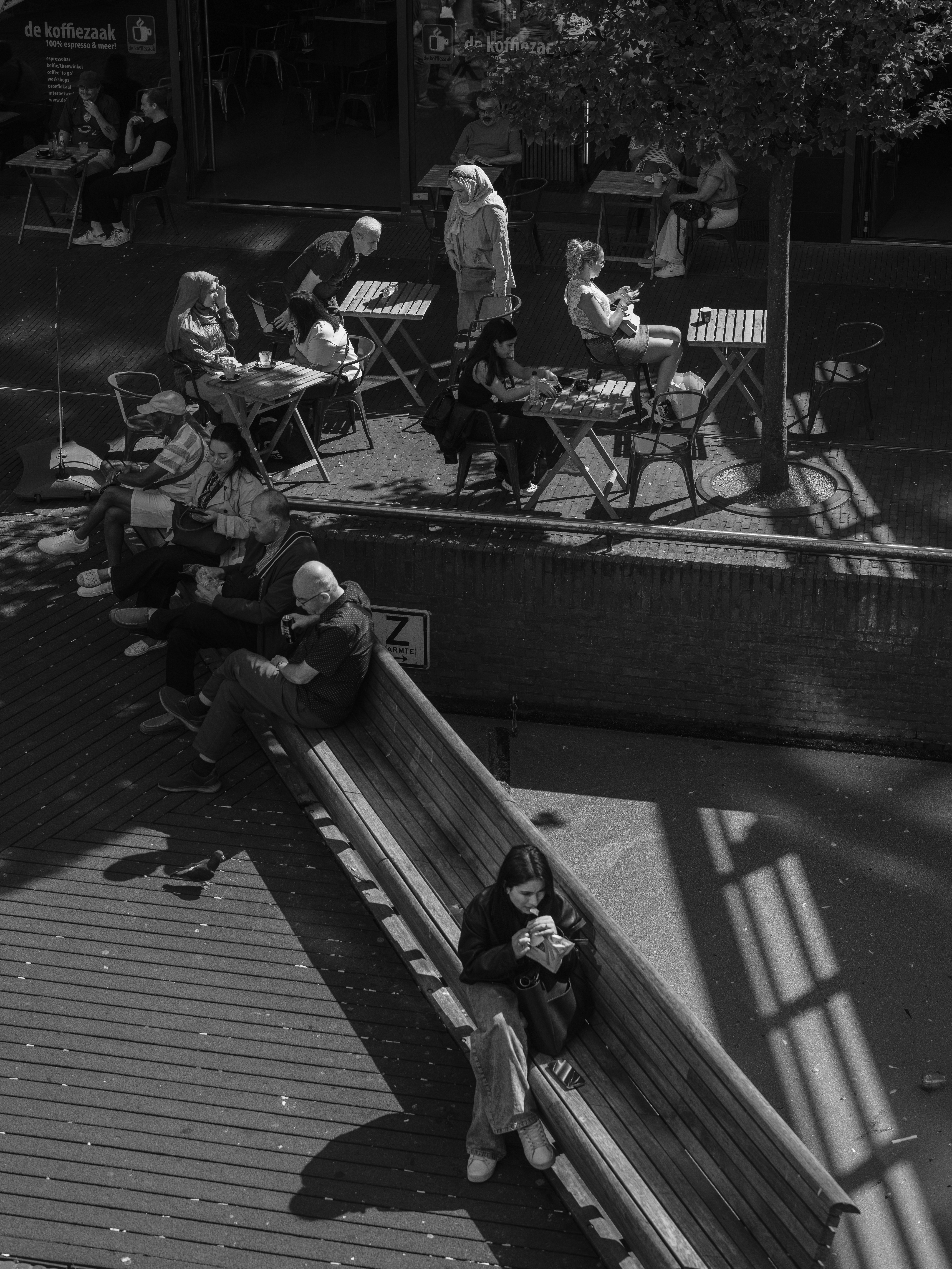 Urban Terrace Portraits: Shadowed Figures and Street Boats