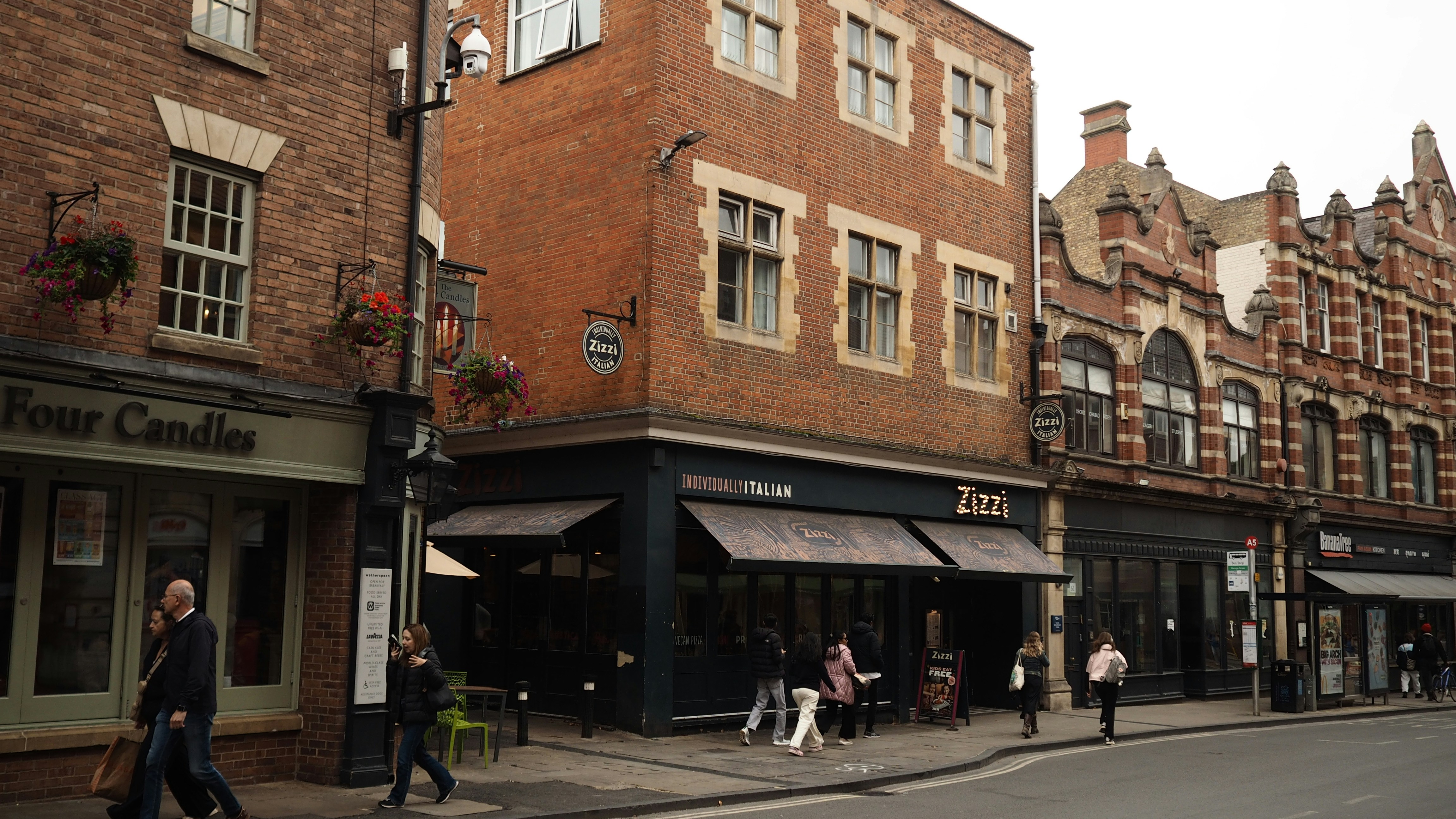 Cobbled High Street: Bricked facades and storefronts under a December sky