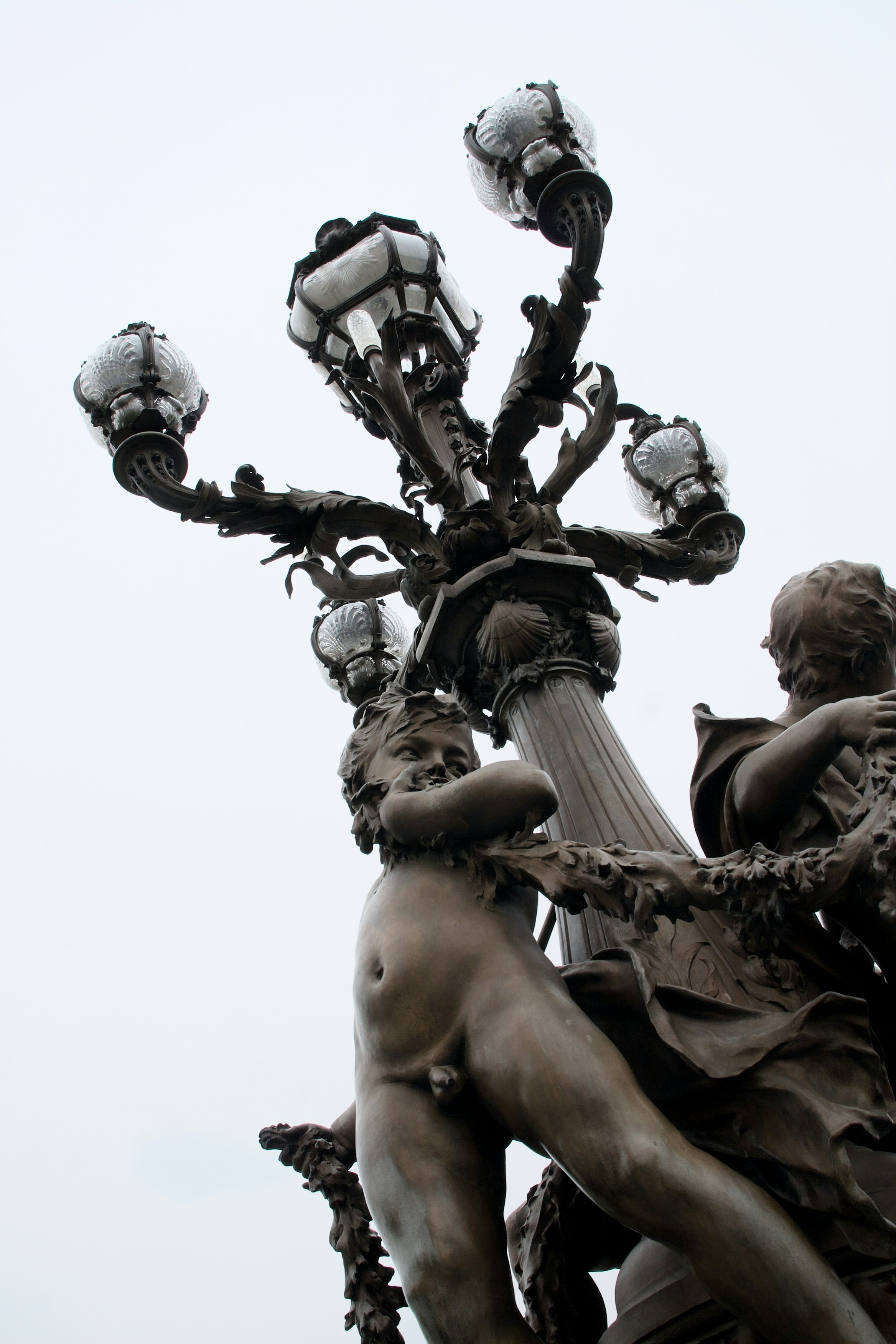 Bronze Elegy: The Gilded Lamp Post and Its Statues Reach Skyward