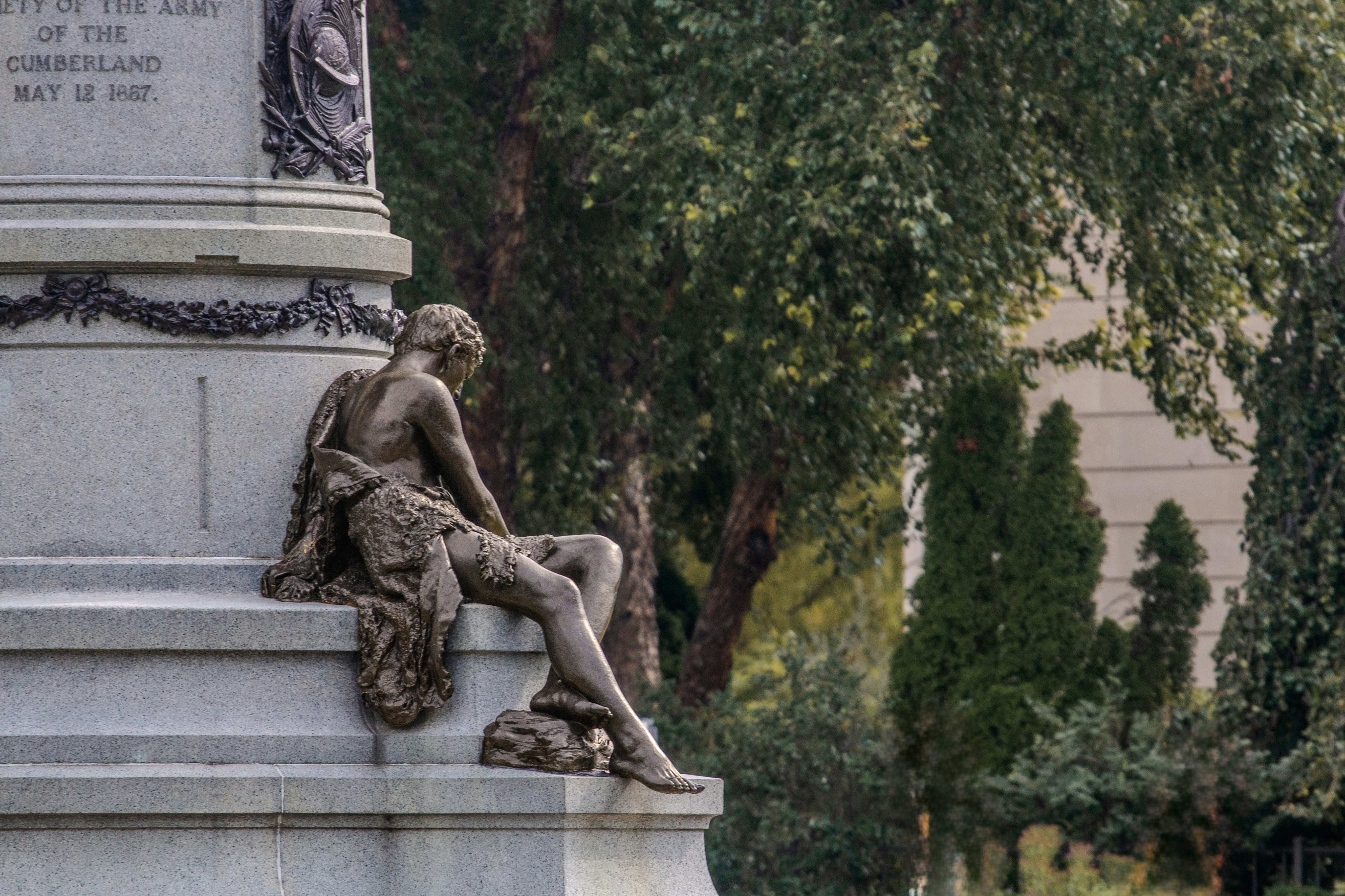 Stone Sentinel: A Solitary Figure Guards the Monument’s Shadow