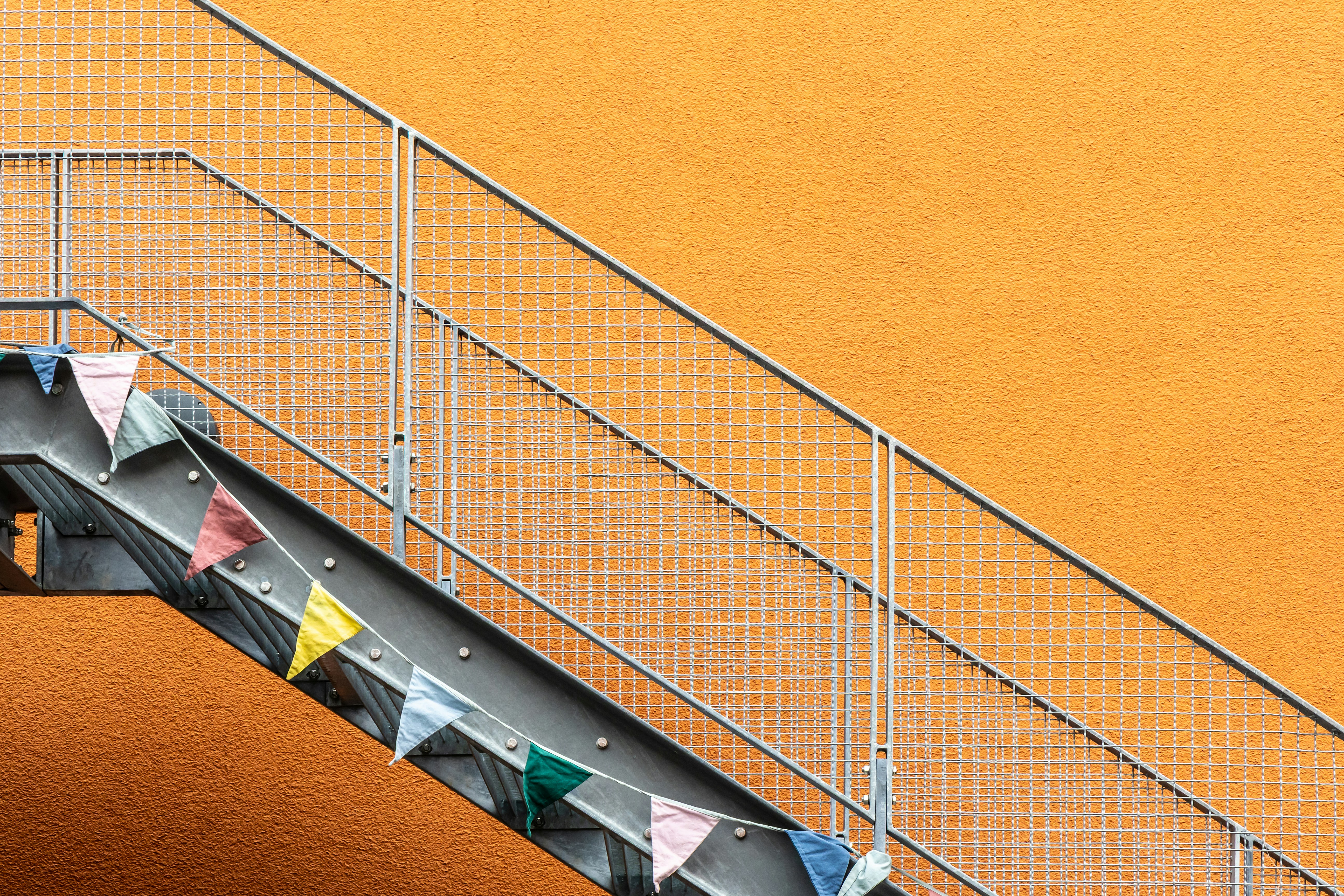 Staircase Geometry Against a Sunlit Orange Wall