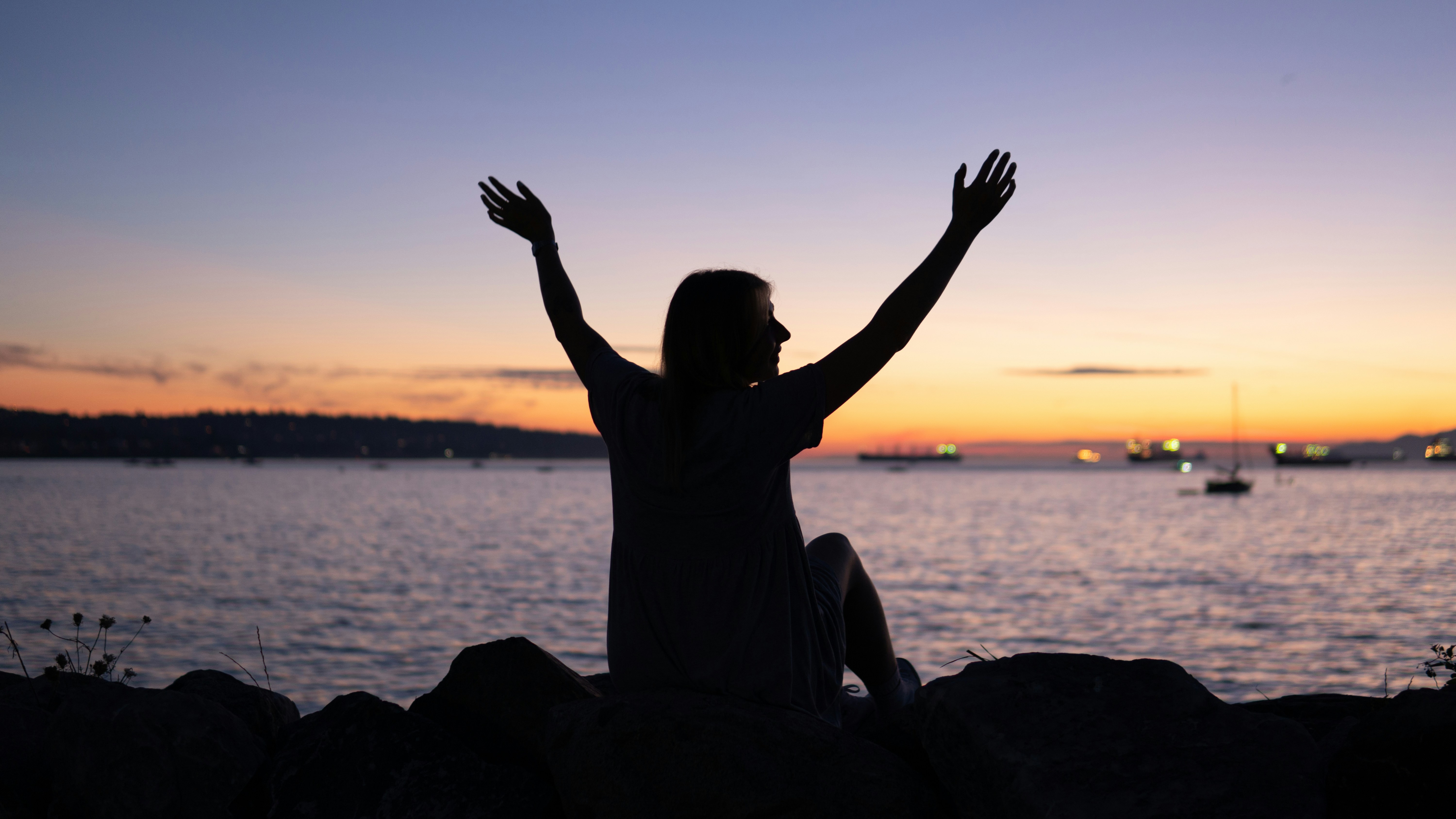 Silhouette Aboard the Horizon: Arms Raised at Sunset