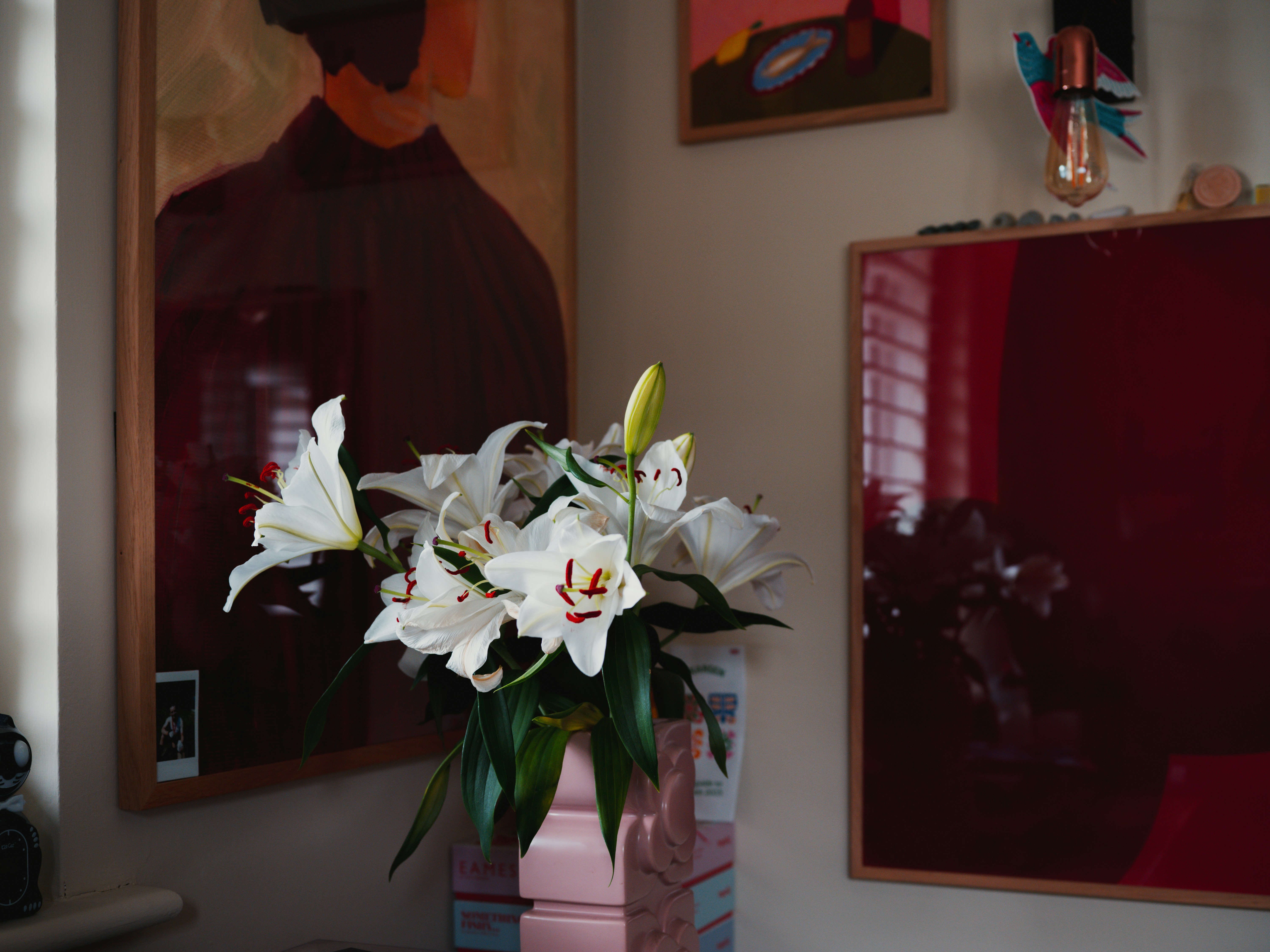 White Lily Bouquet in a Pink Vase Anchoring a Quiet Corner