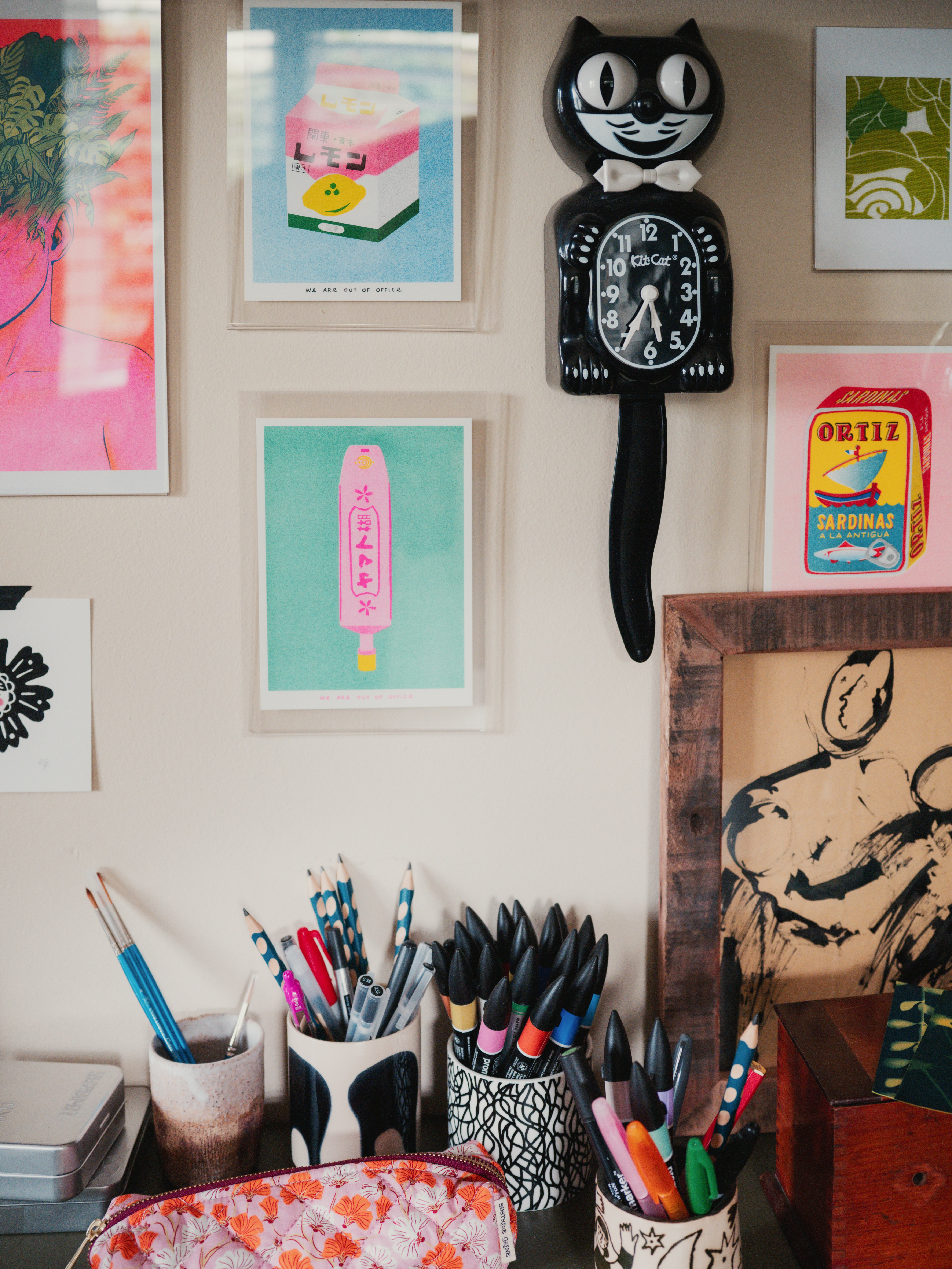 Whimsical Studio Wall: A Clock Cat Watches Over Colorful Tools