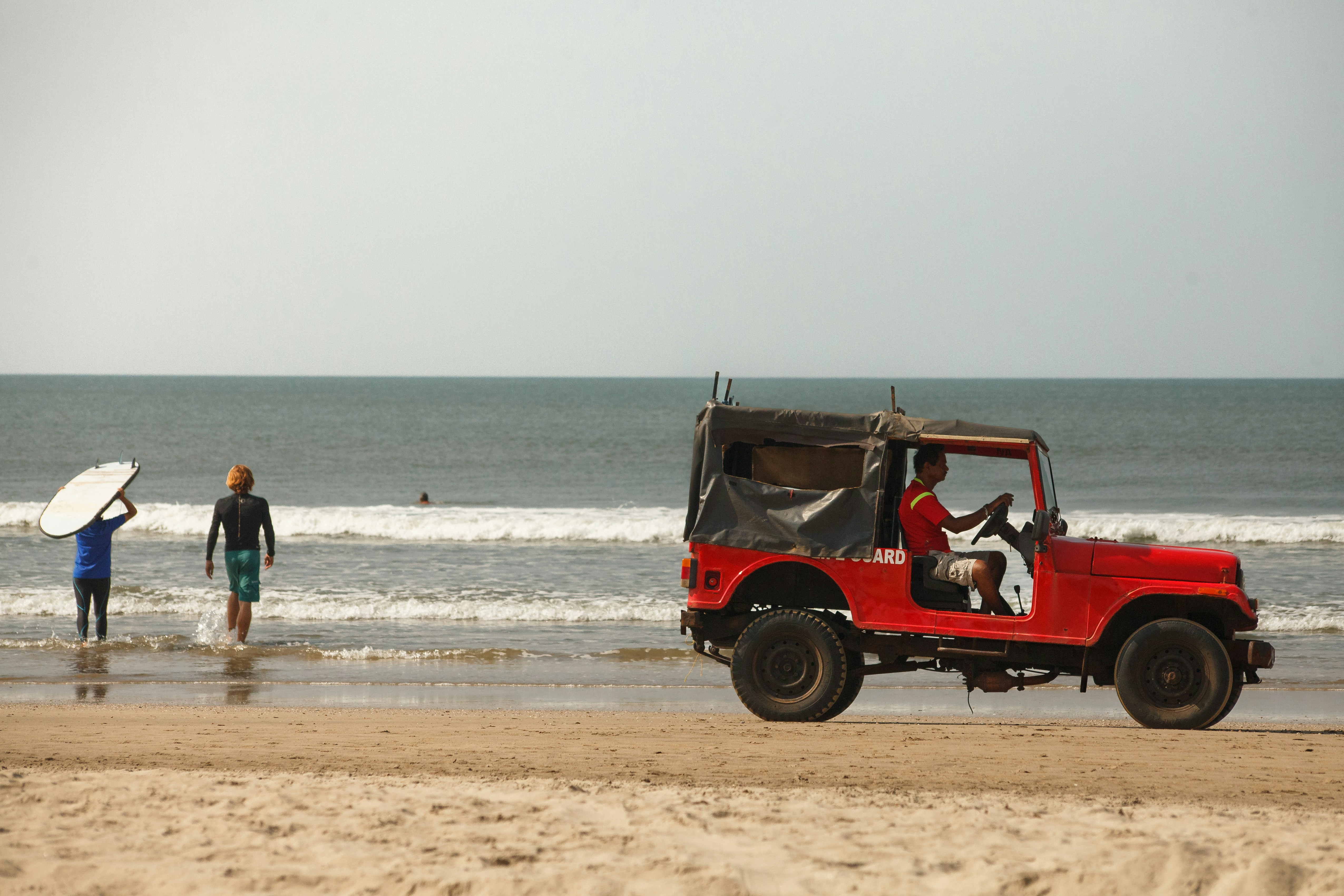 Red Jeep by the Shore: A Quiet Beach Patrol