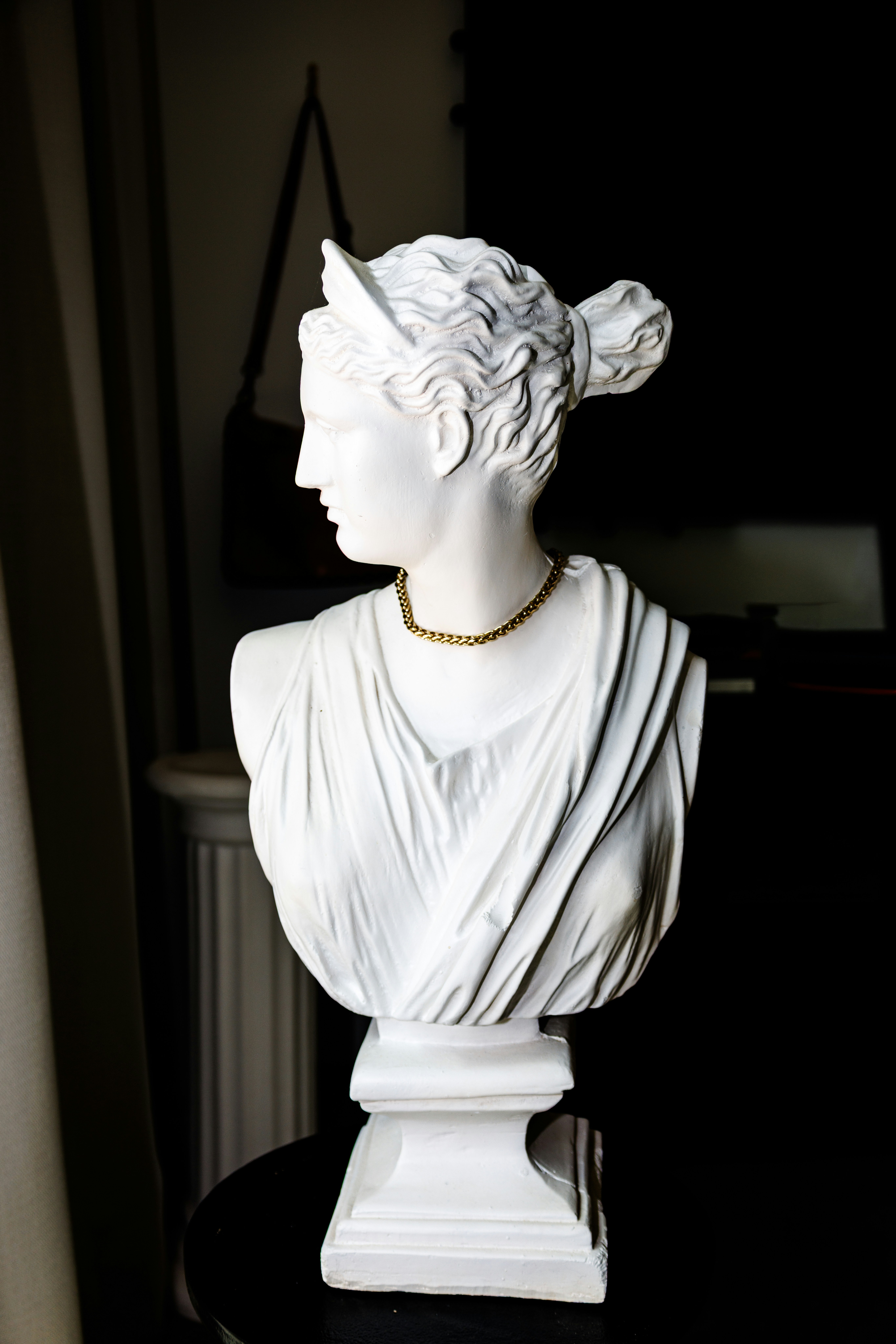 Whisper of Marble: Classical Bust in a Dimly Lit Interior