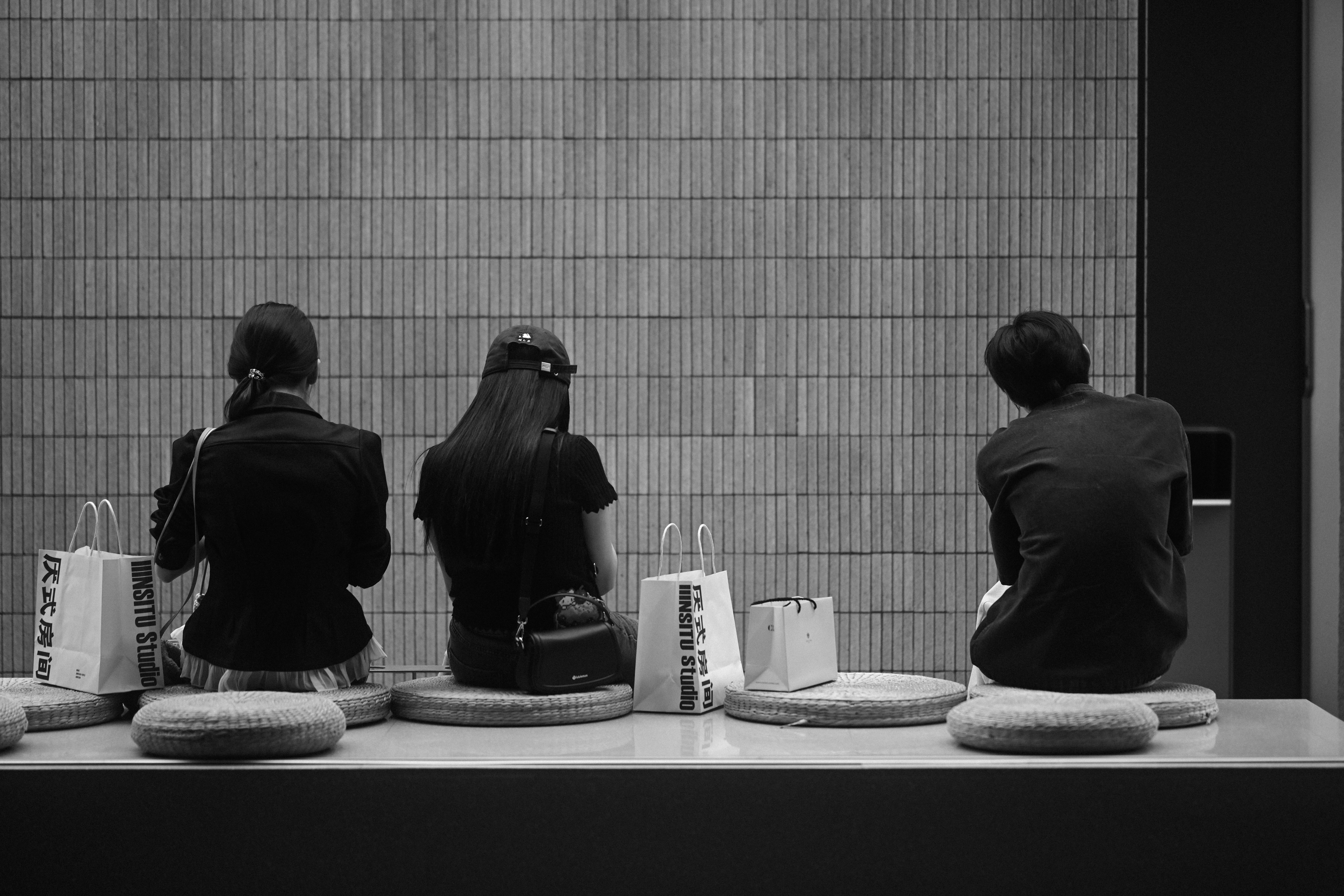 Evening Rail: Three Silent Figures on a Subway Bench