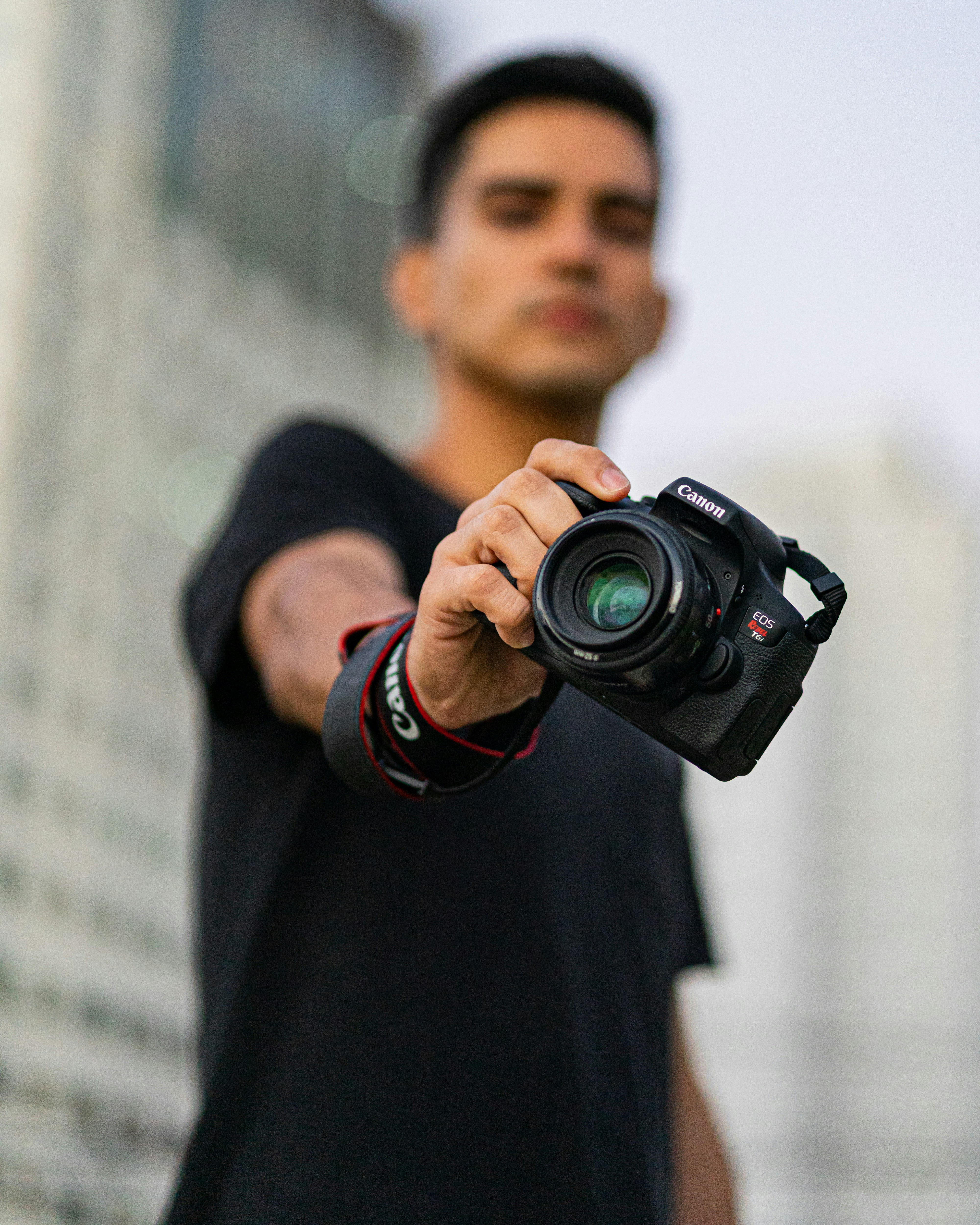 Outstretched Canon: A Hand-Tilted Moment toward the Viewer