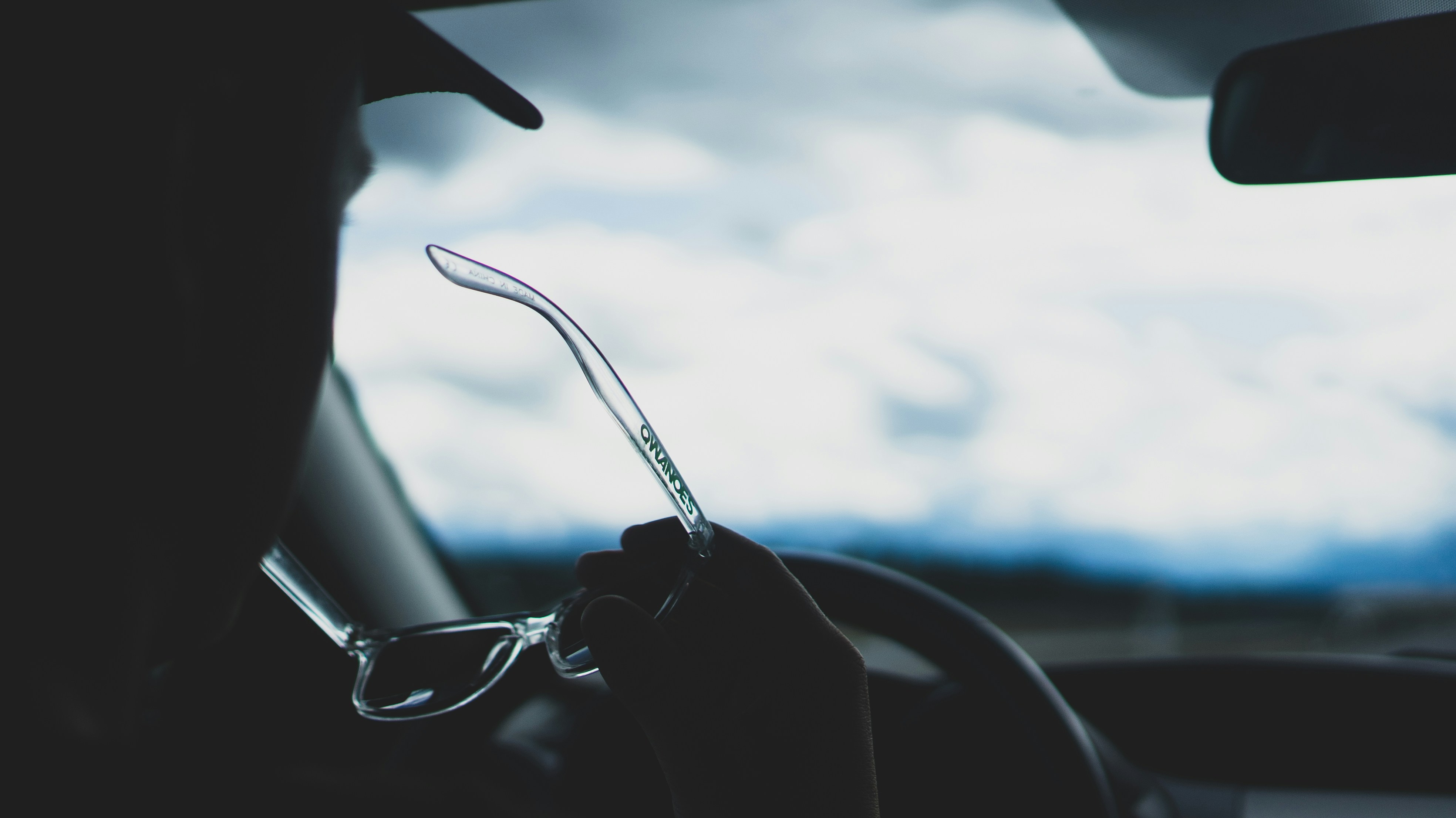Glance from the Driver's Seat: A Quiet Moment with Reading Glasses