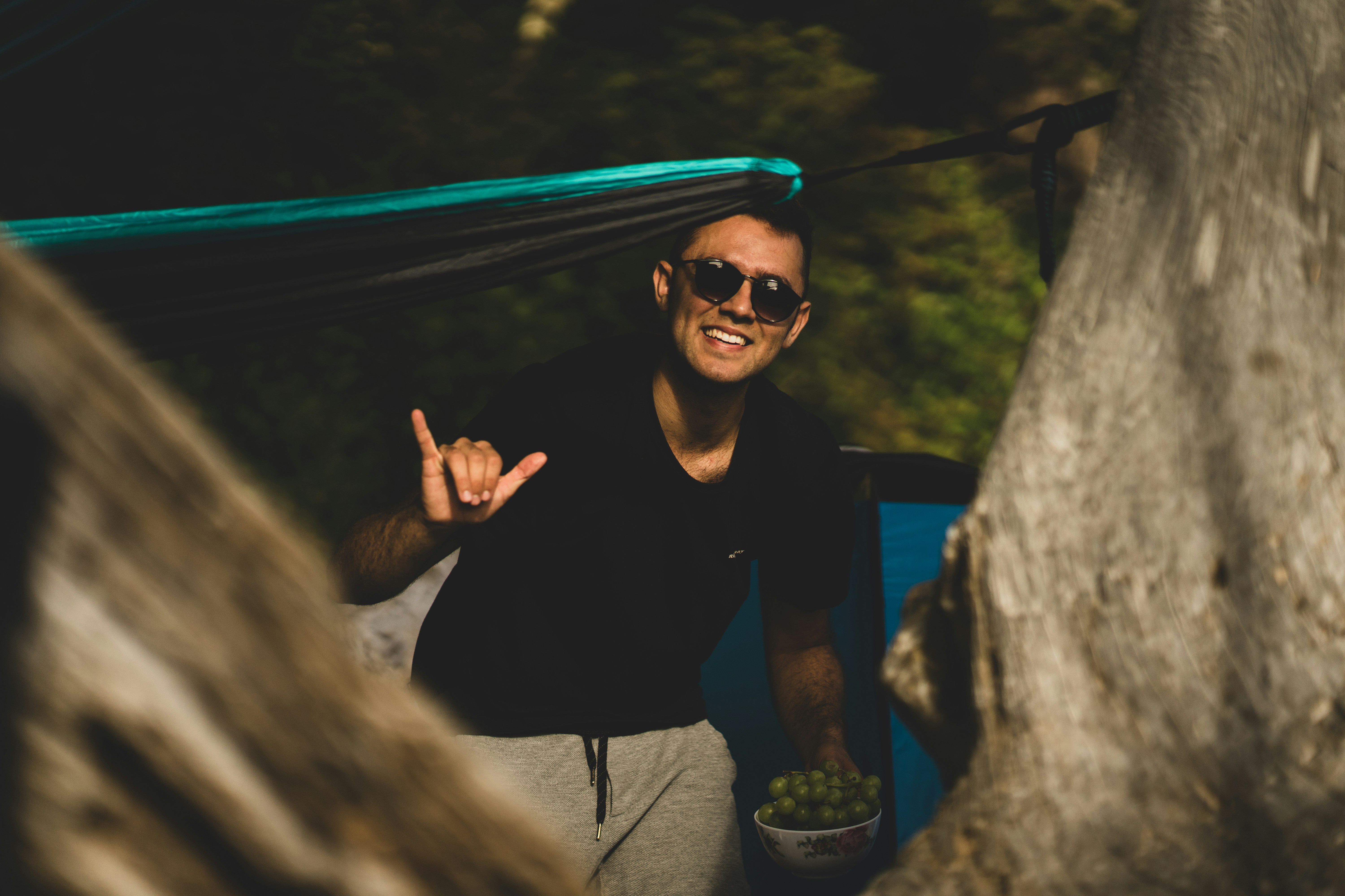 Smiling in the Shade: A Campfire Hero Beside the Hammock
