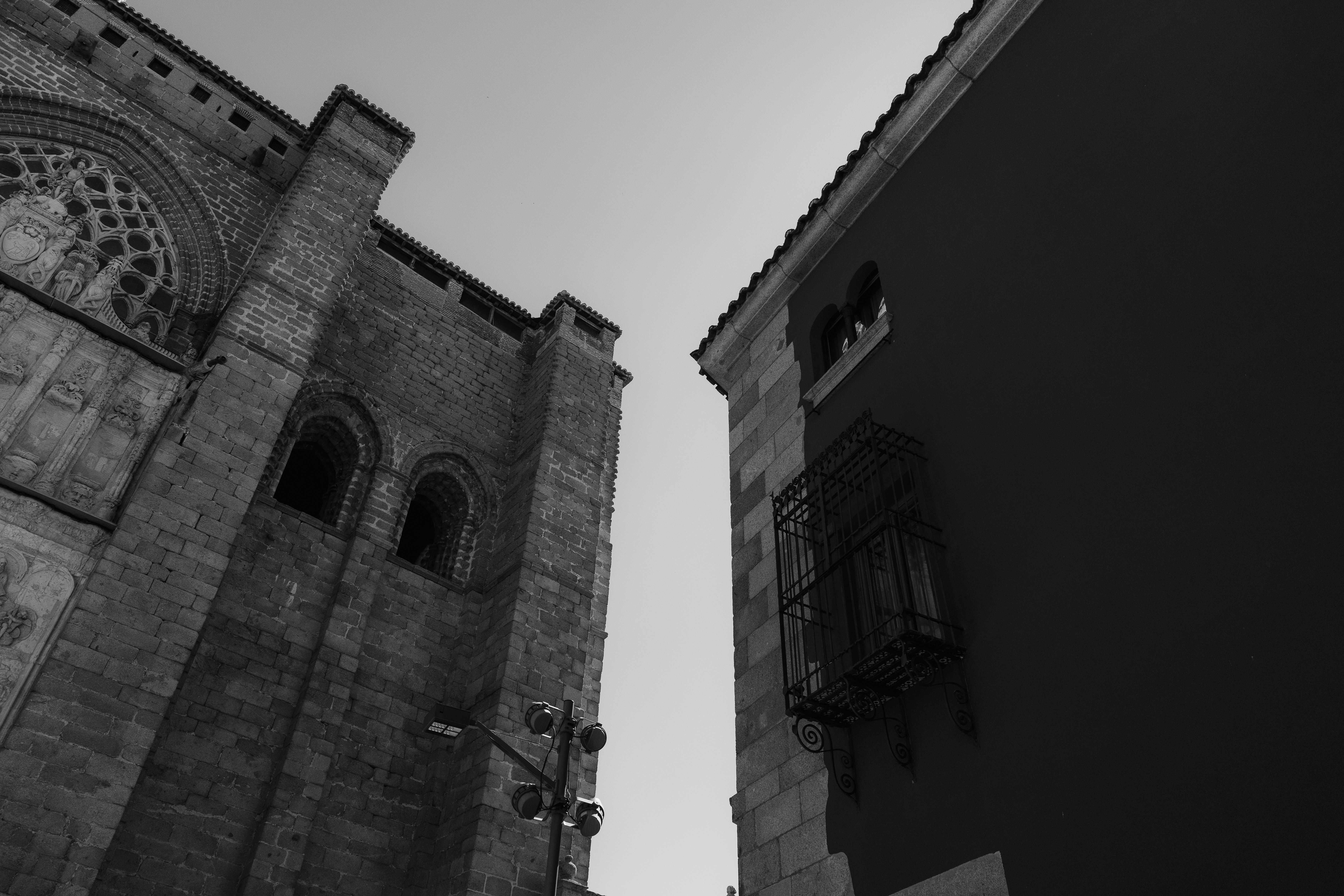 Stone Cathedral Meets Modern Facade: A Narrow Sky Between Giants