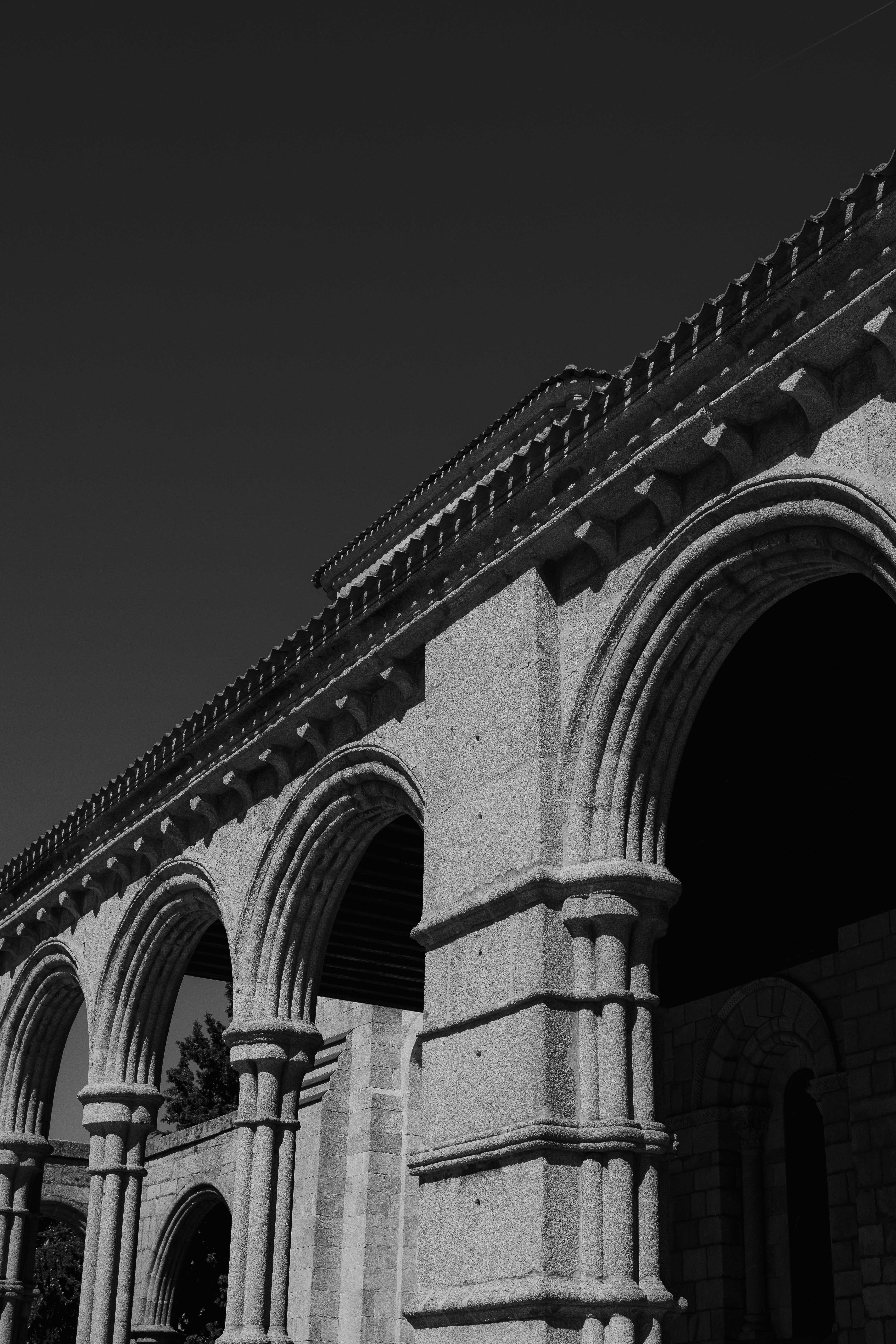 Arched Stone Corridor Reaching Toward a Clear Sky