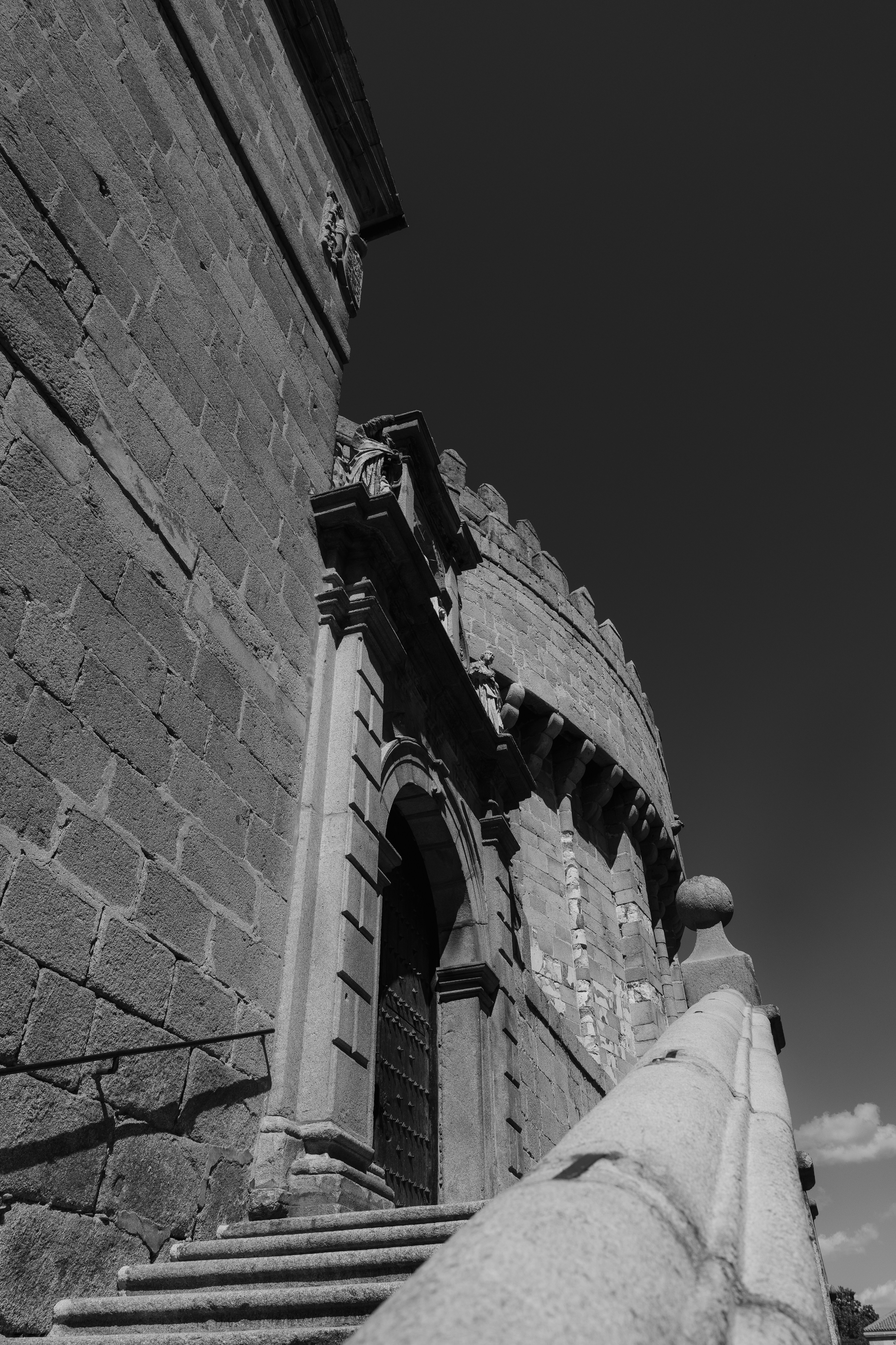 Stone Gatekeeper: A Tilted Facade Under Wide Sky
