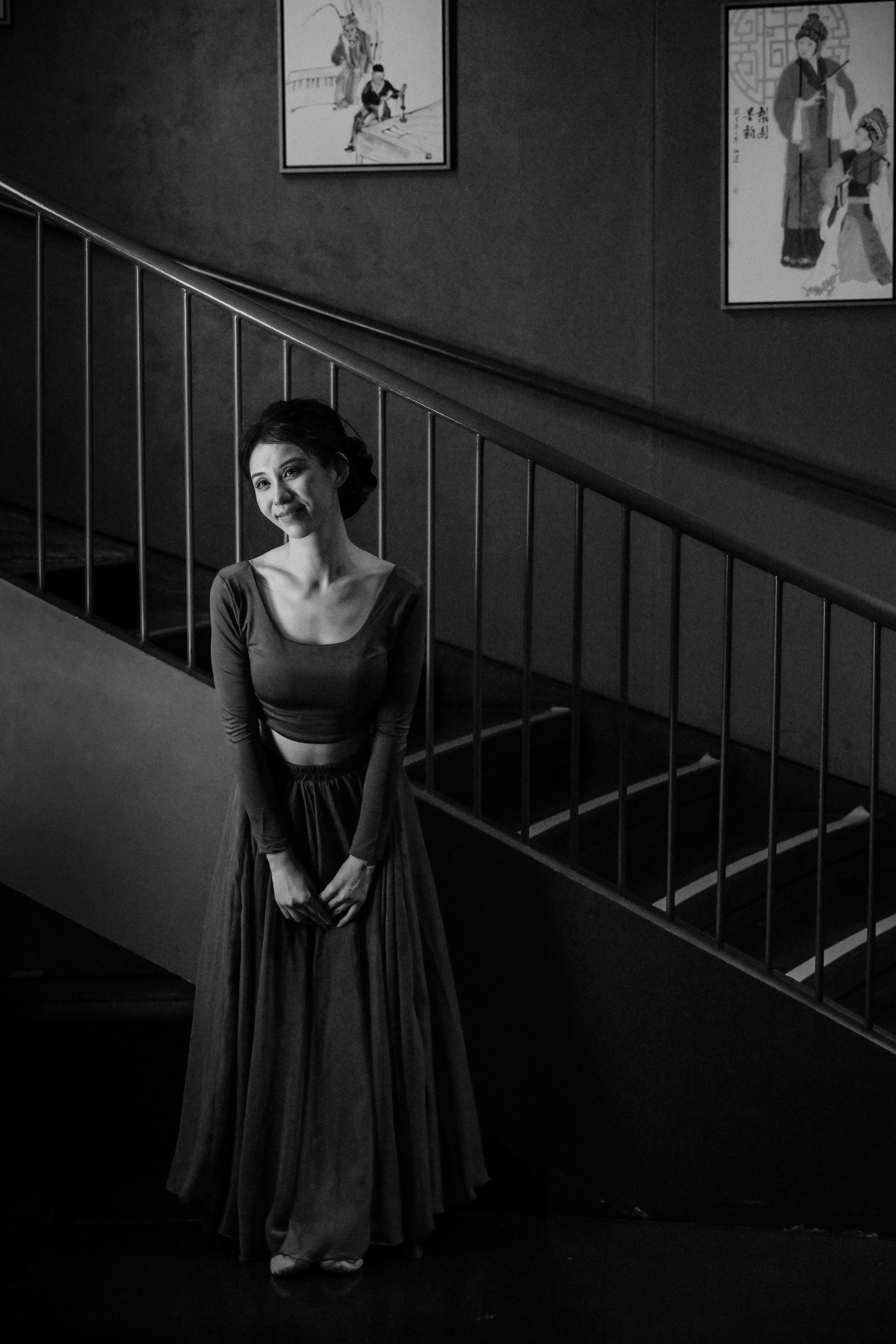 Grace Beneath the Staircase: A Portrait in Quiet Contrast