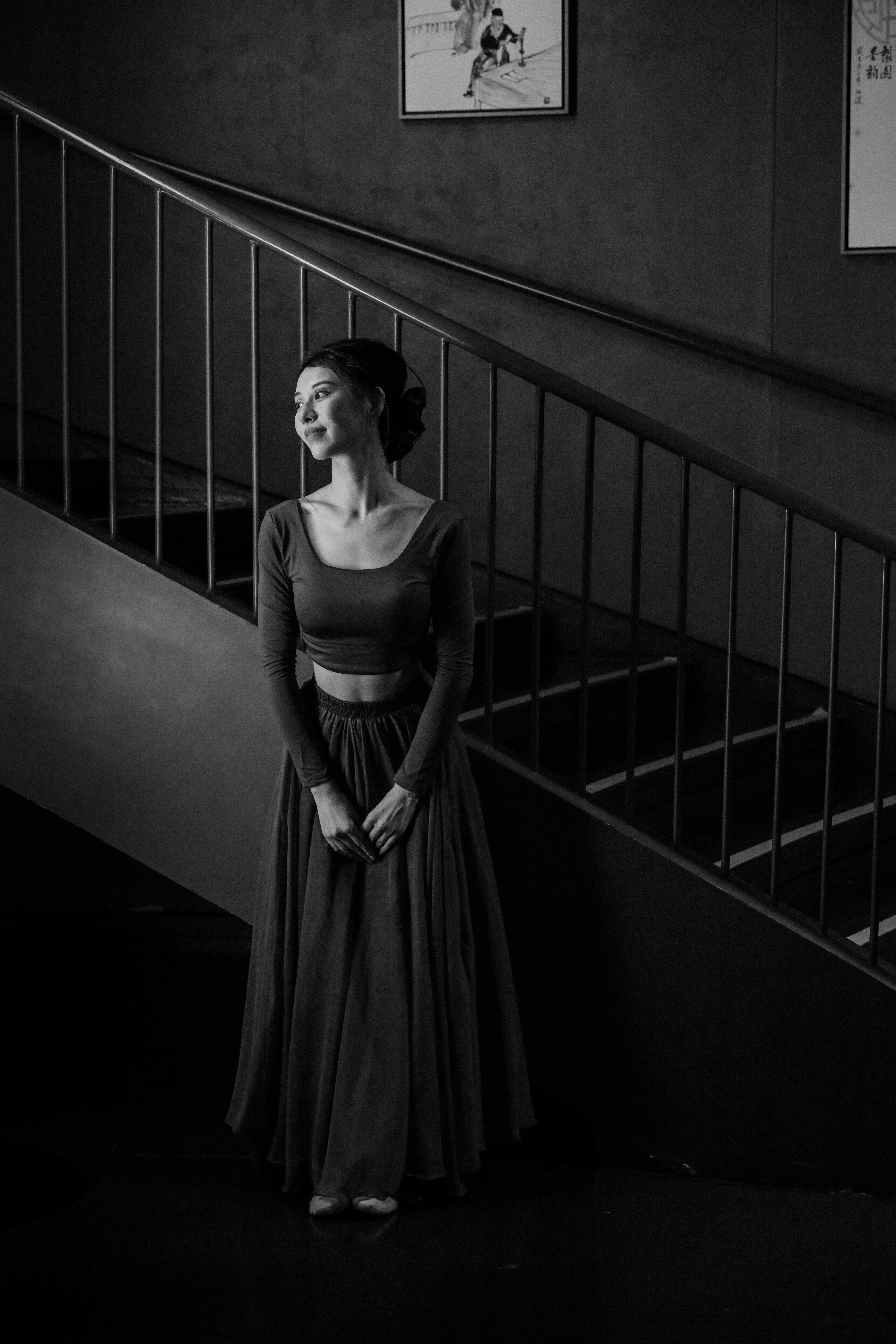 Grace on the Stair: A Dimly Lit Poise