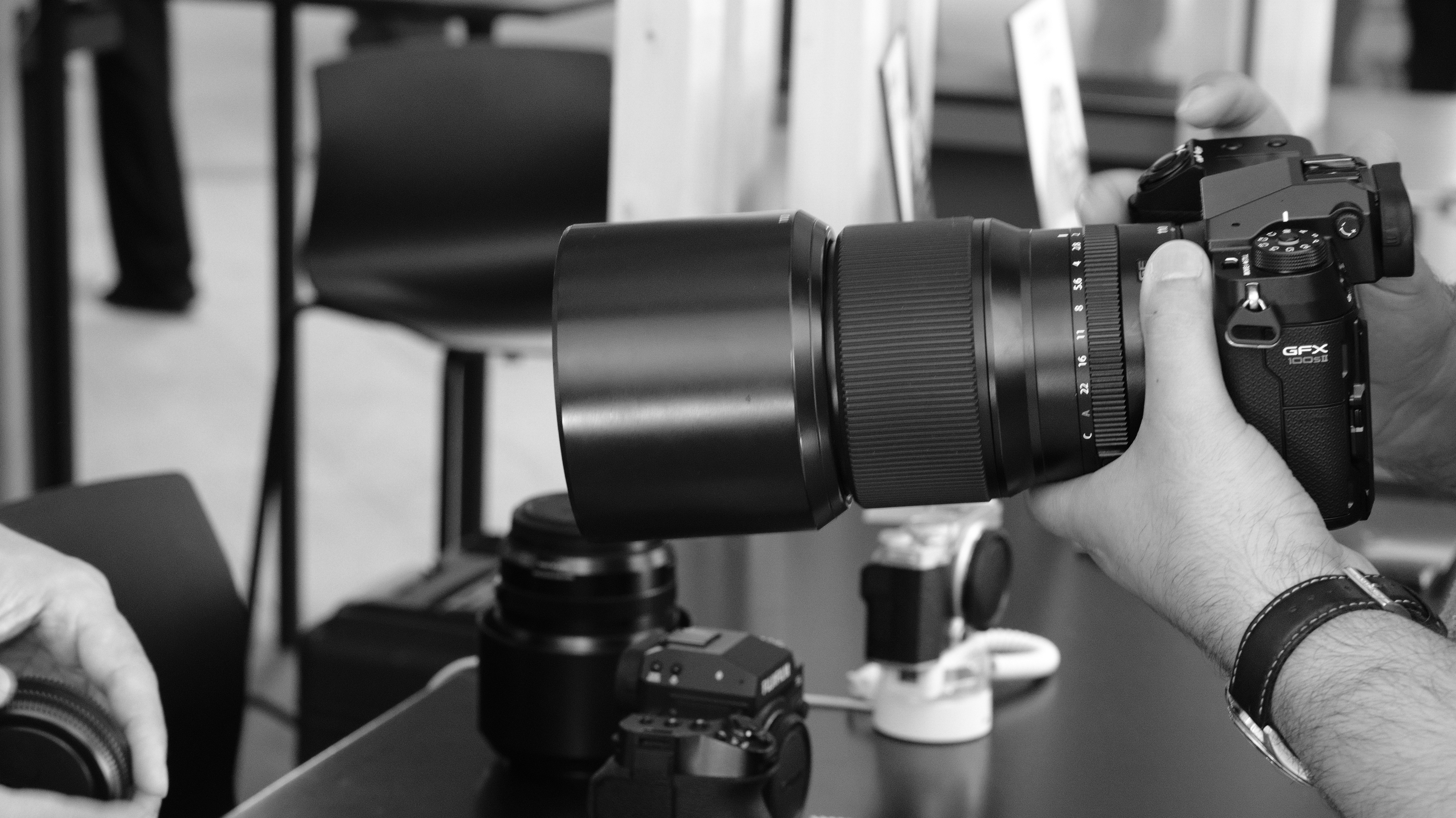 Hands-on Studio Moment: A Photographer Balances Lens and Doorway to Silence