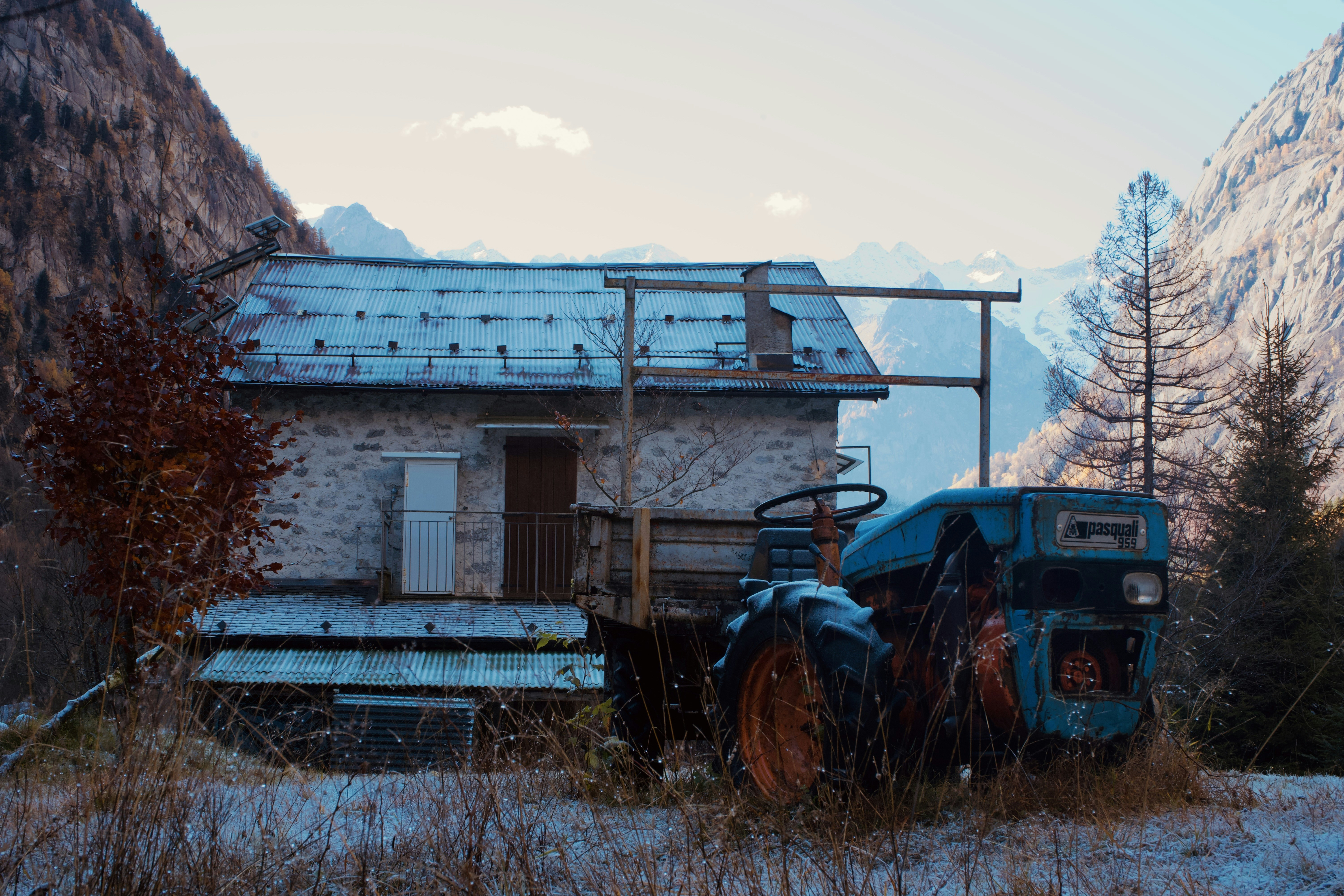 Old Farmstead and Tractor Resting Under Alpine Snow