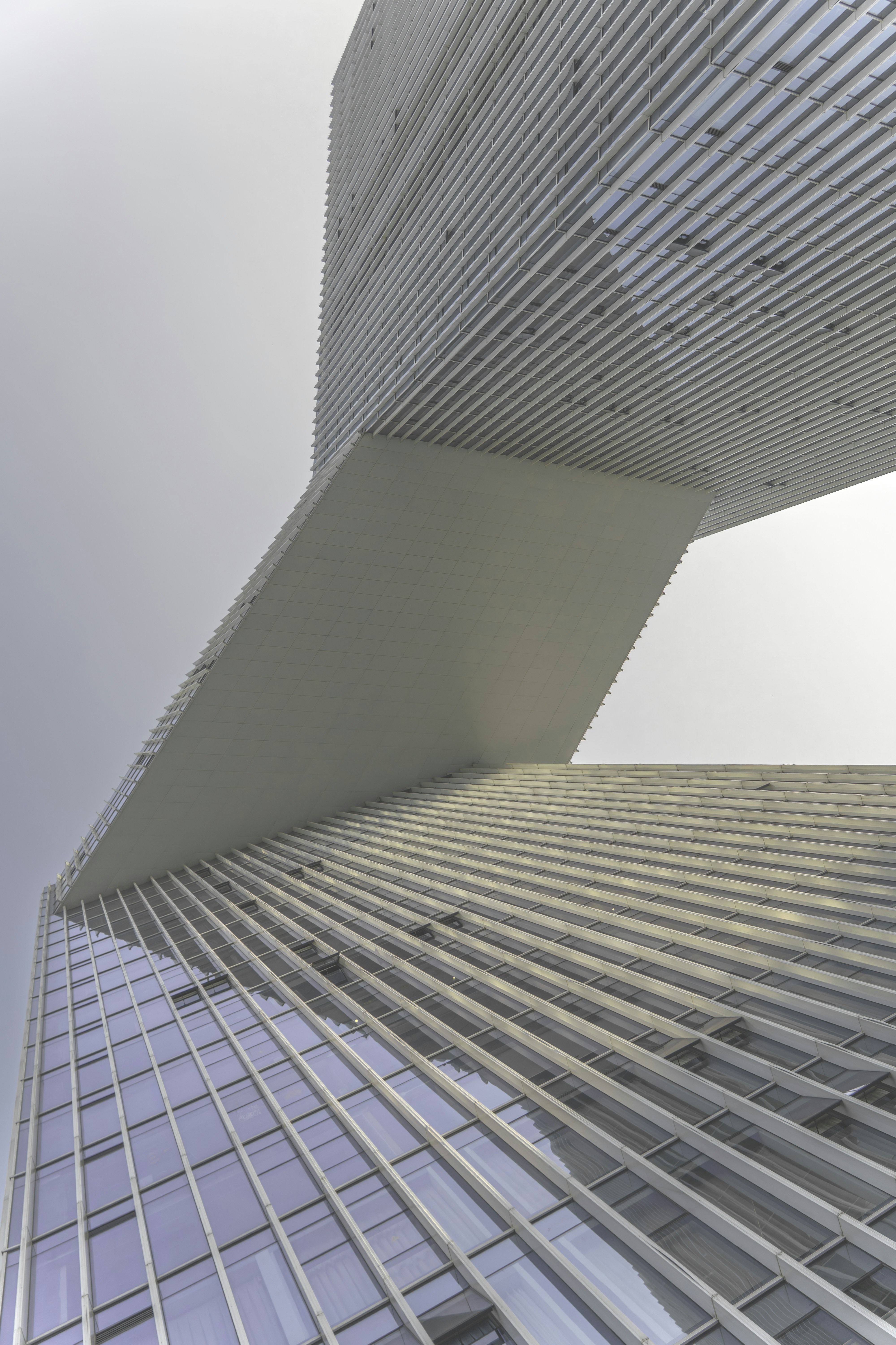 Skyward Convergence: A Tilted Dance of Glass and Steel