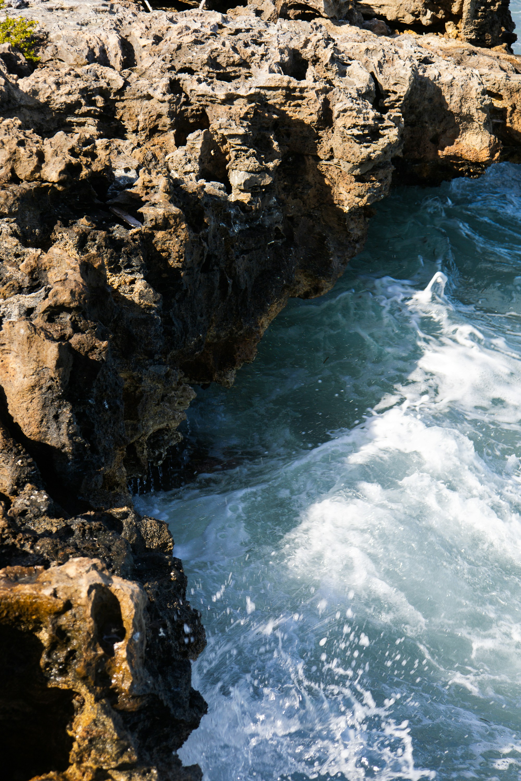 Craggy shoreline over turquoise surge