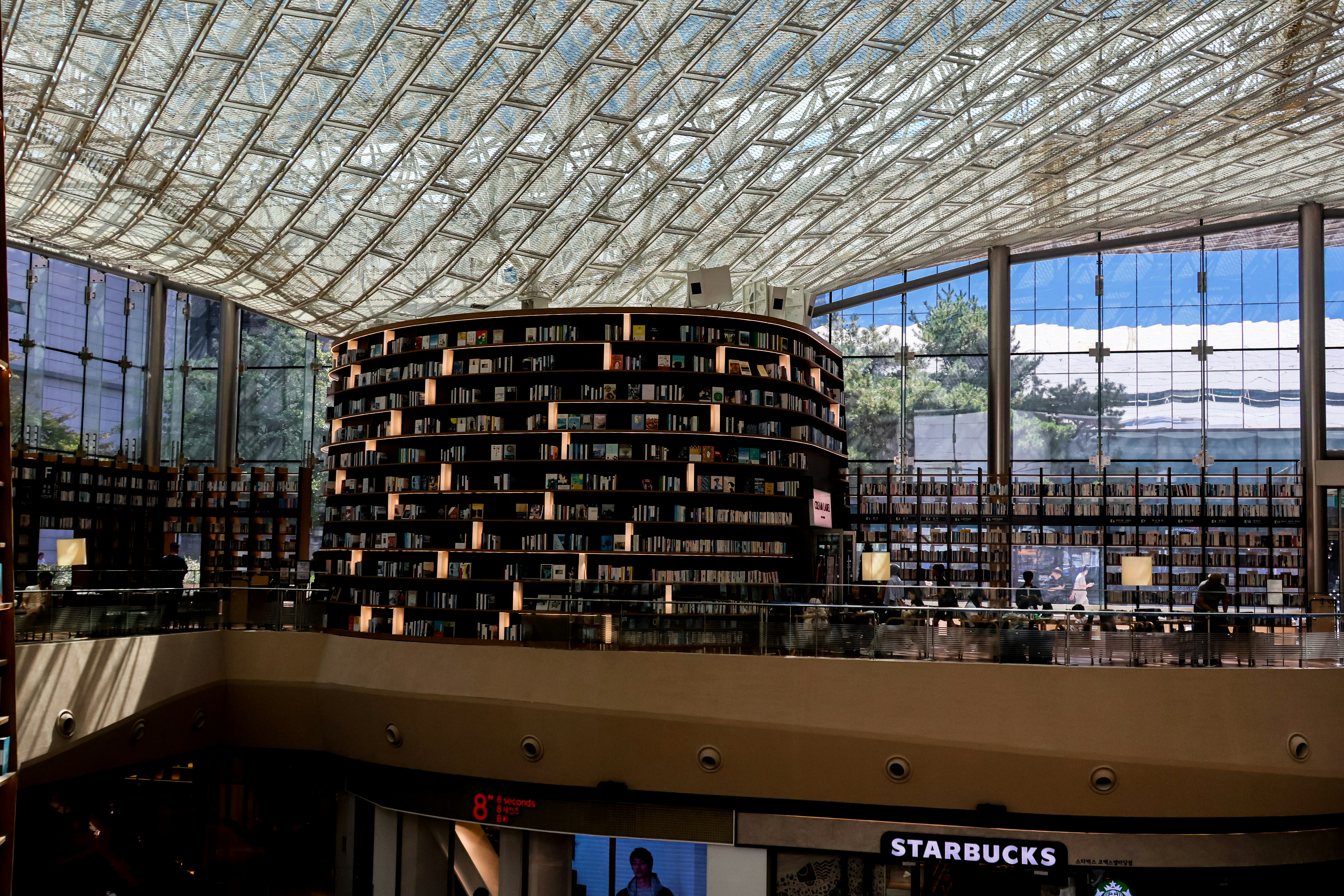 Circular Library Oasis Under Glass: A Four-Level Atrium of Books