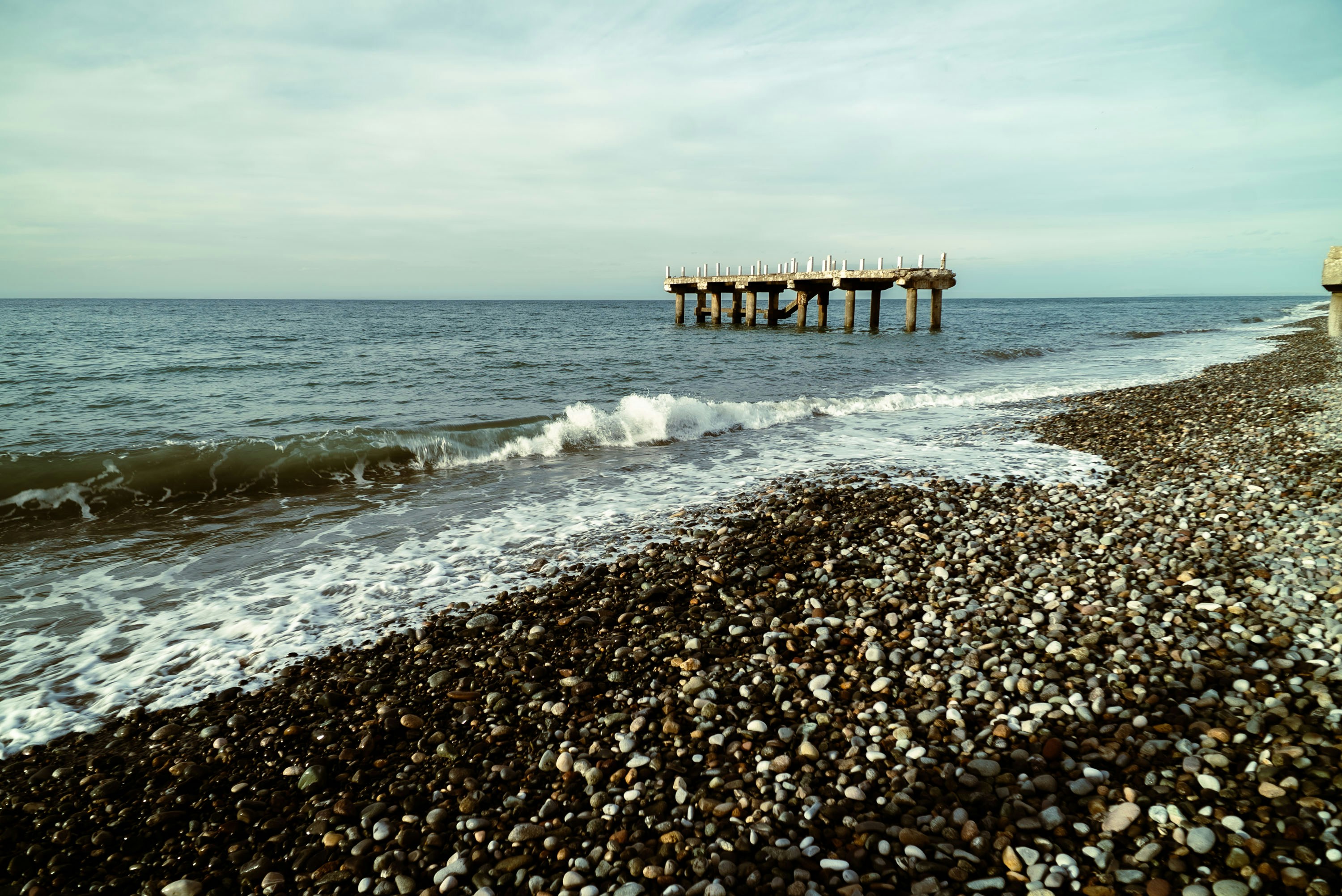 Pebble Shorelines and Distant Pier