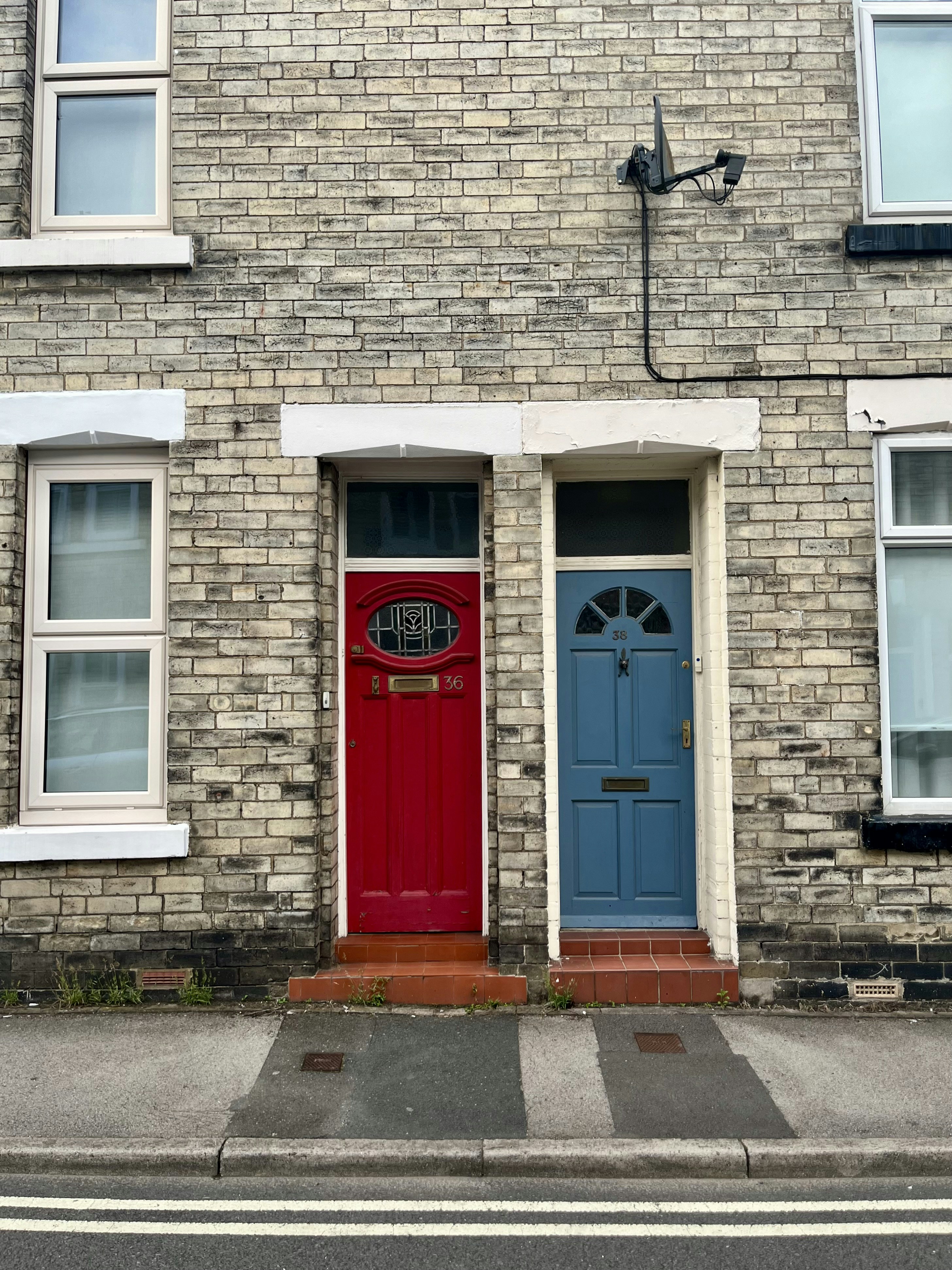 Red and Blue Doors: A Facade of Brick and Character