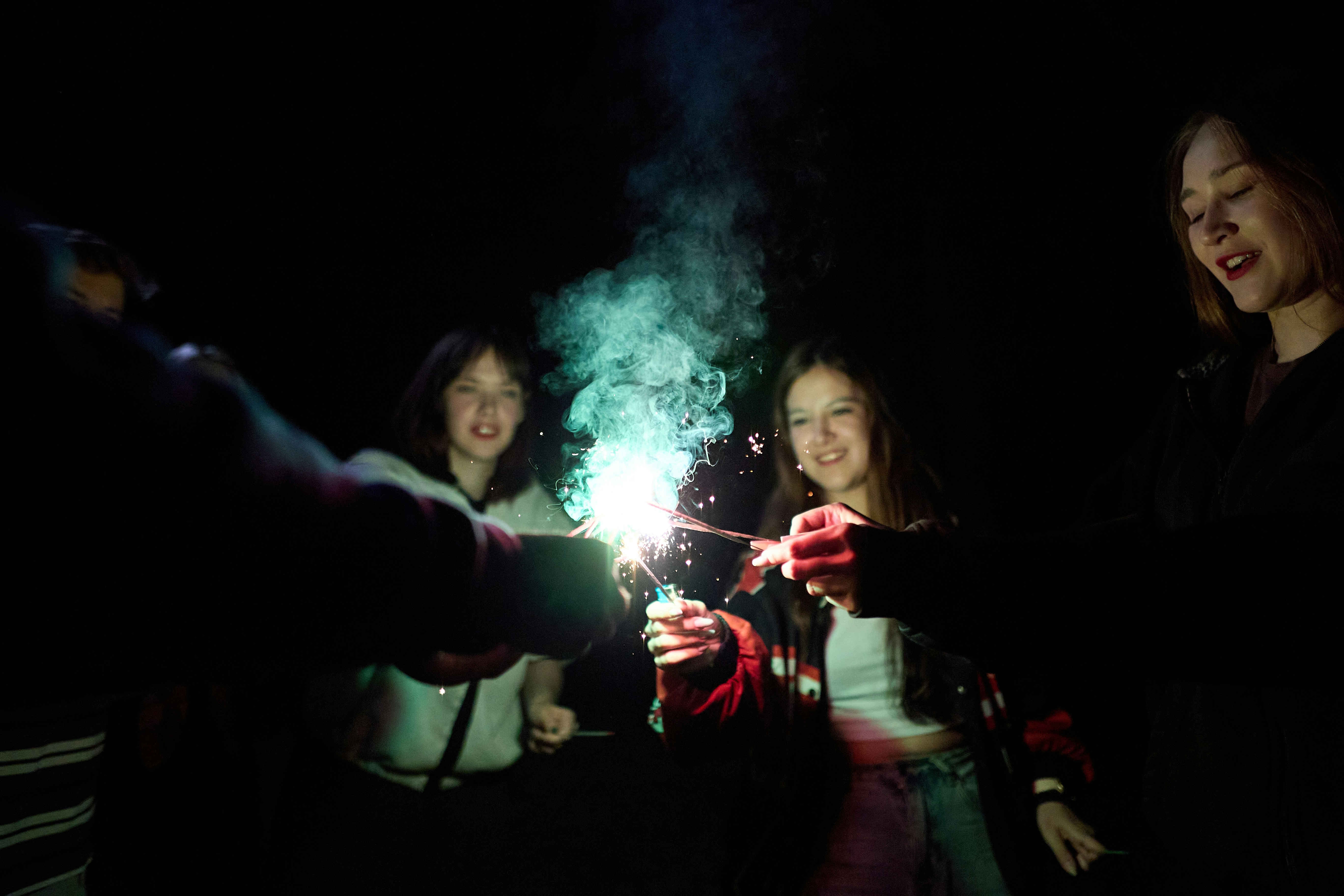 Midnight Sparks: Friends Circle a Glowing Torch