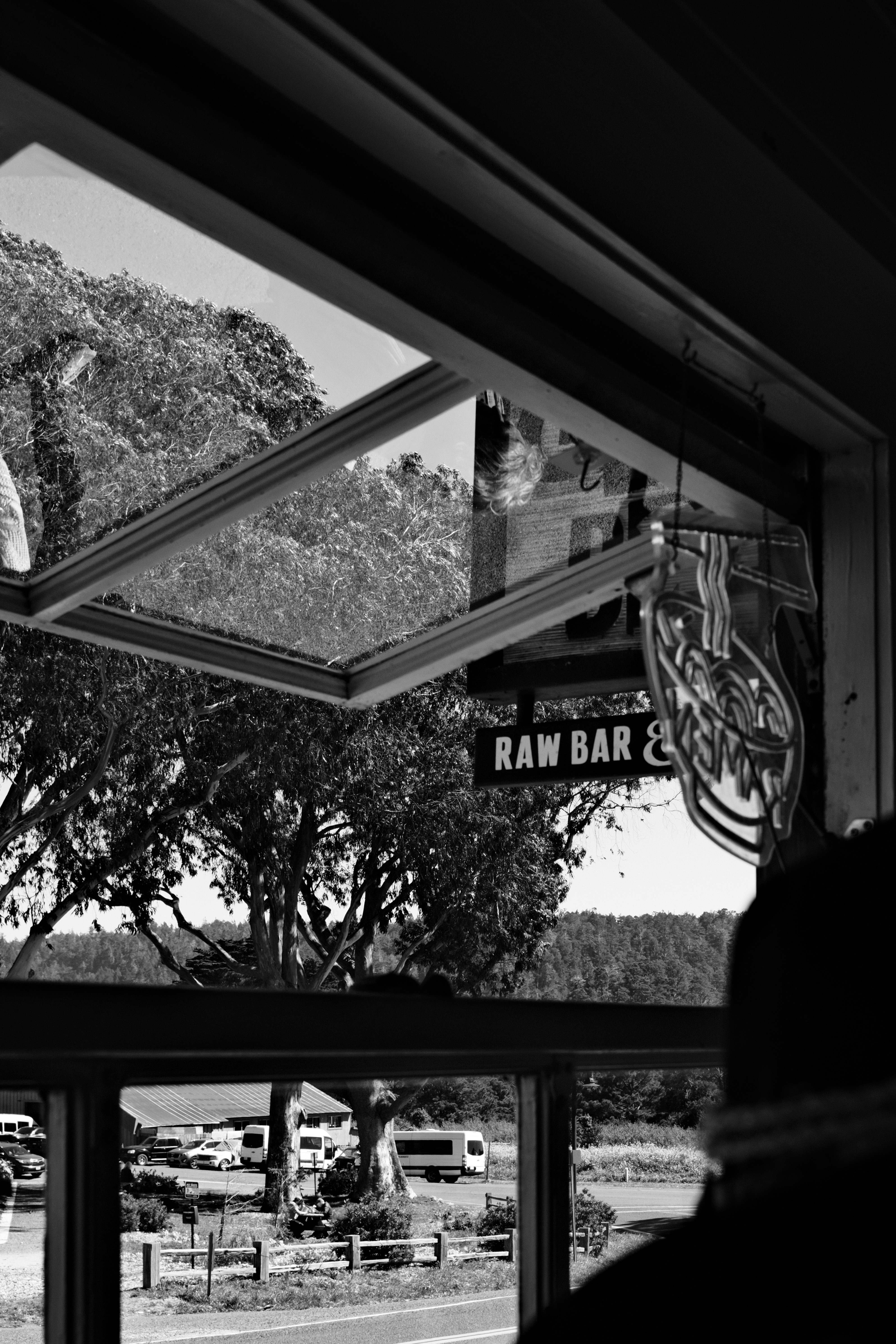 Open Window, Quiet Outdoors: A Bar Scene Framed by Glass