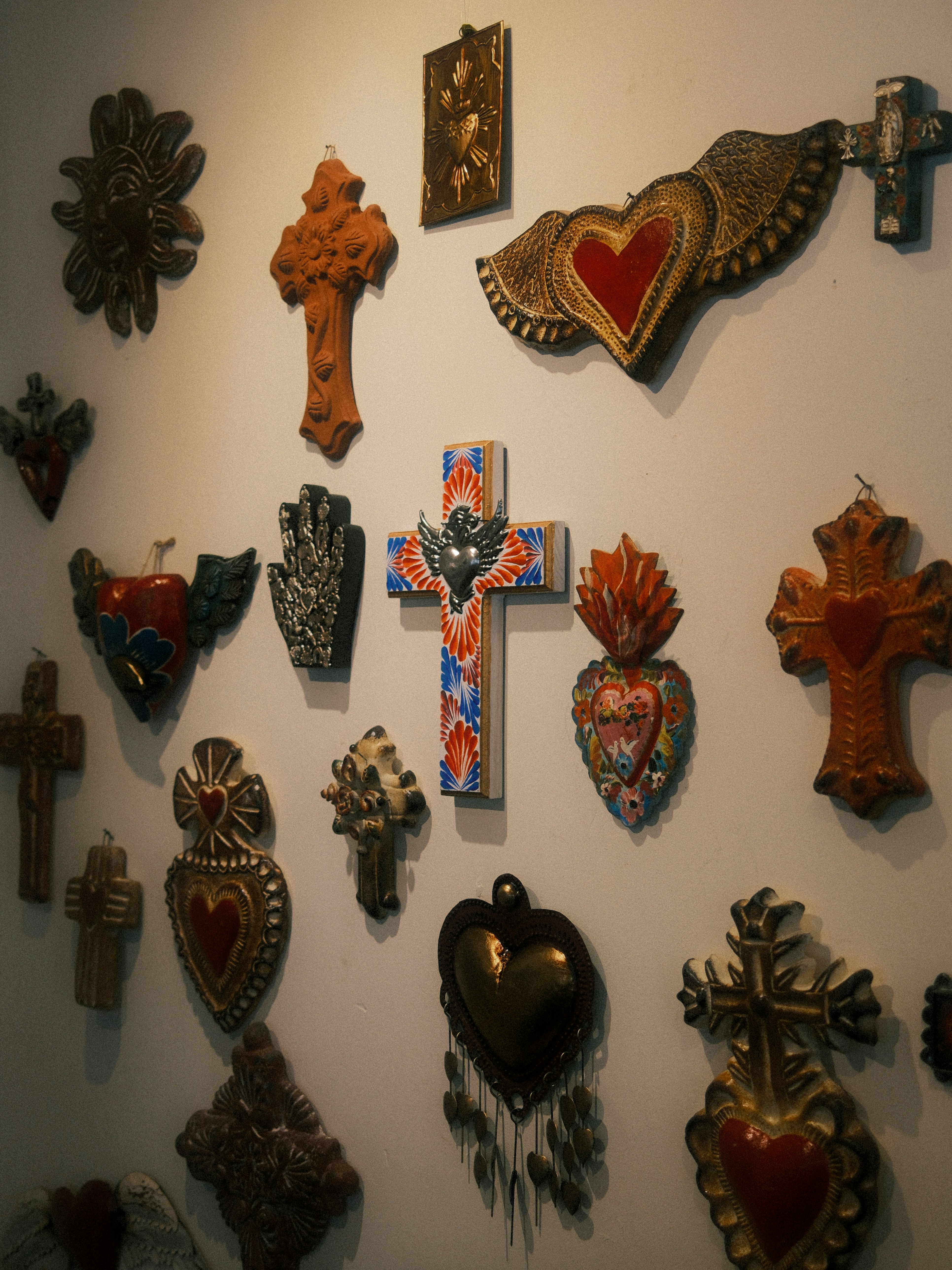 Wall of Hearts and Crosses: A Mosaic of Sacred Trinkets