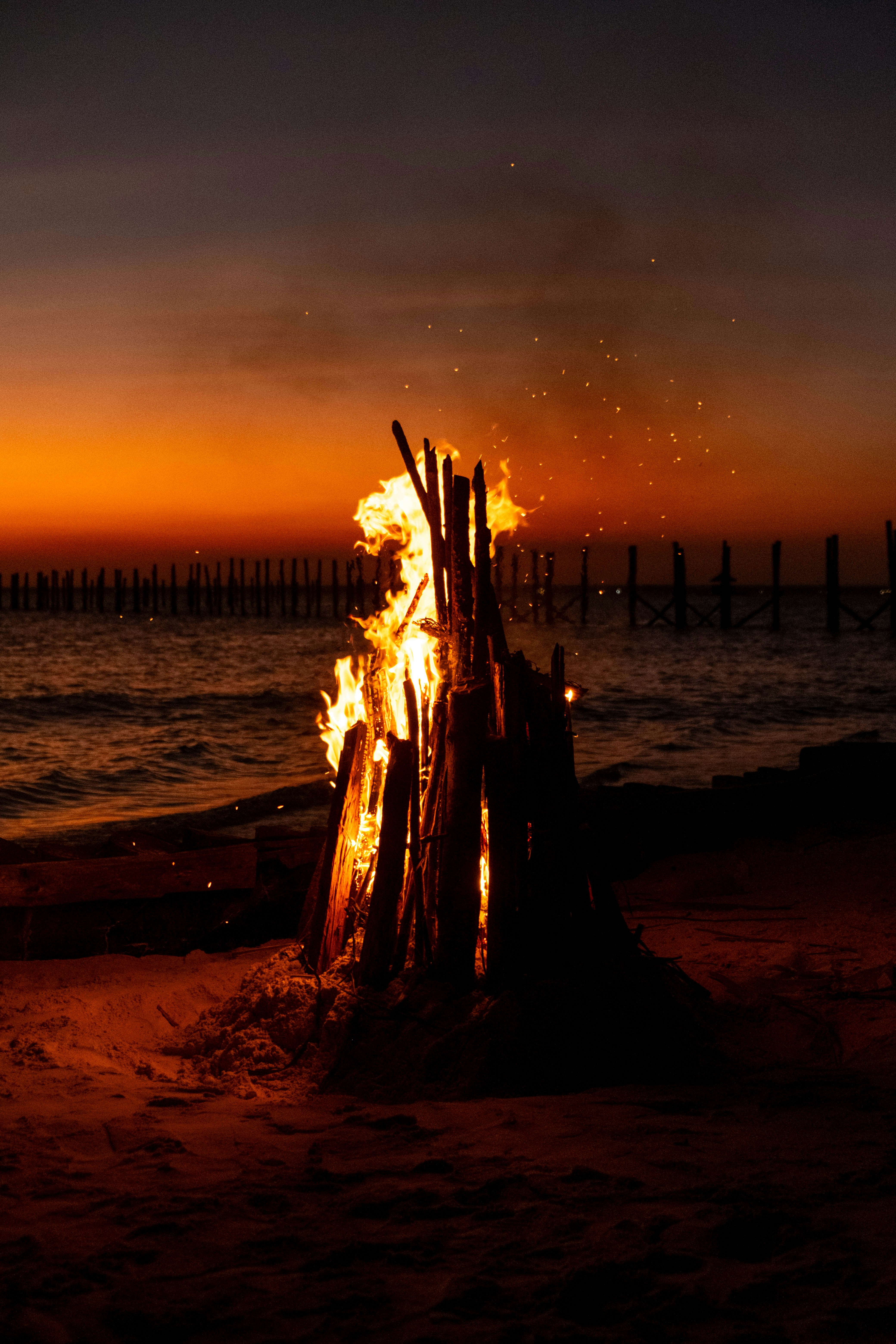 Rigged Skewer of Light: A Coastal Fire at Dusk