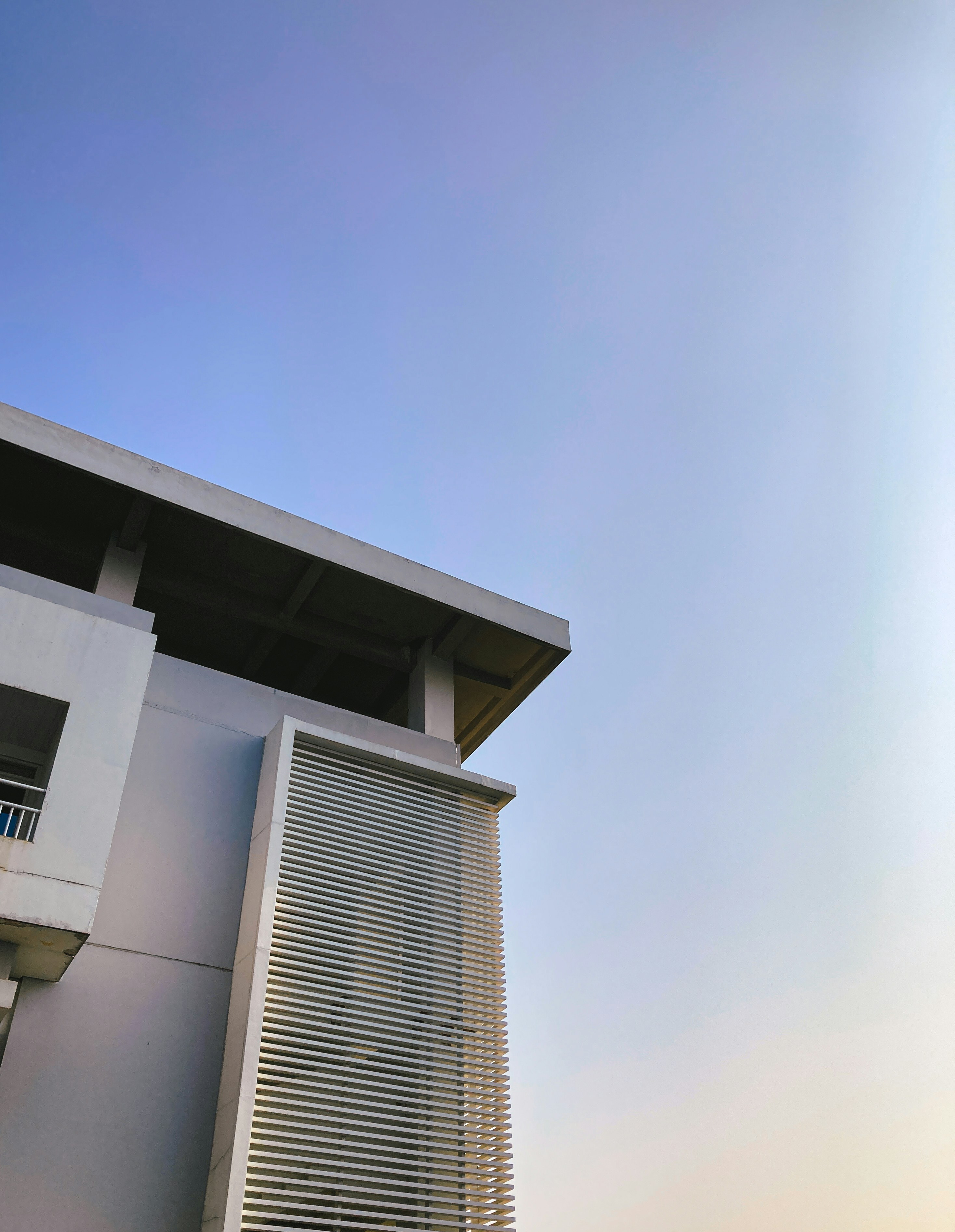 Angular Minimalism: A White Modernist Corner Reaches Toward a Sky