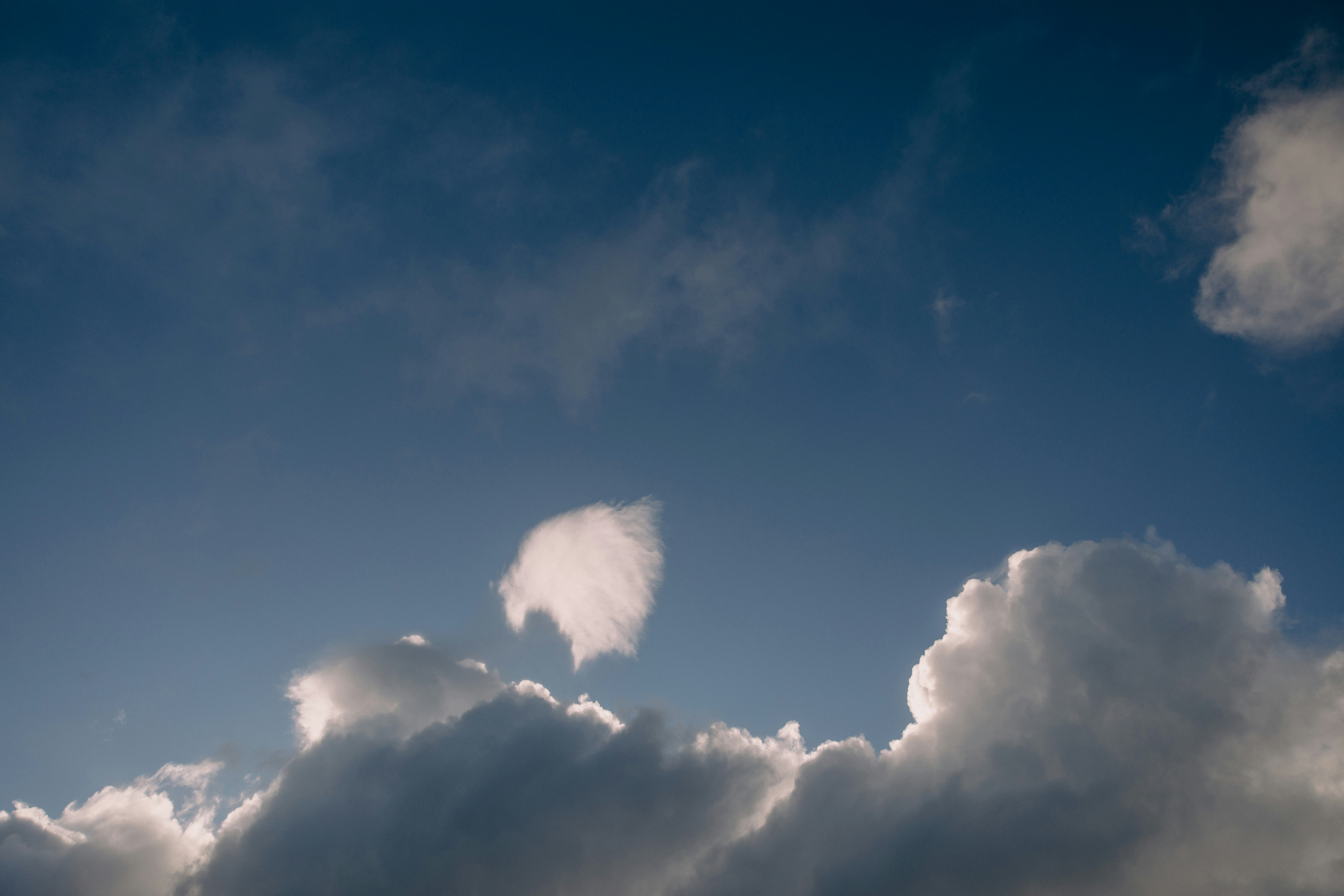 Dreamscape Sky: Cloud Formations Curl Over a Quiet Horizon