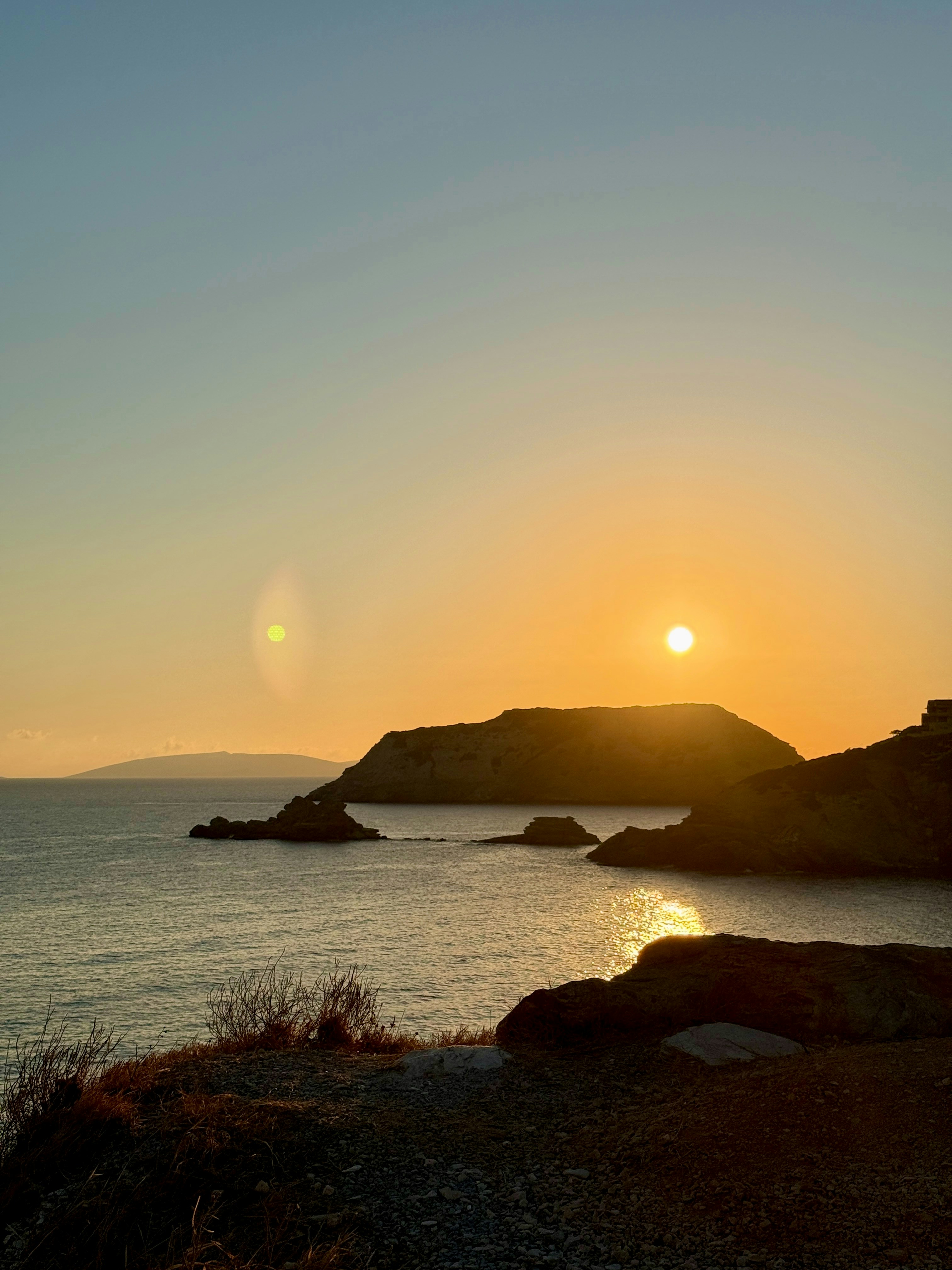 Sunlit Cliffs Over Calm Seas at Sunset