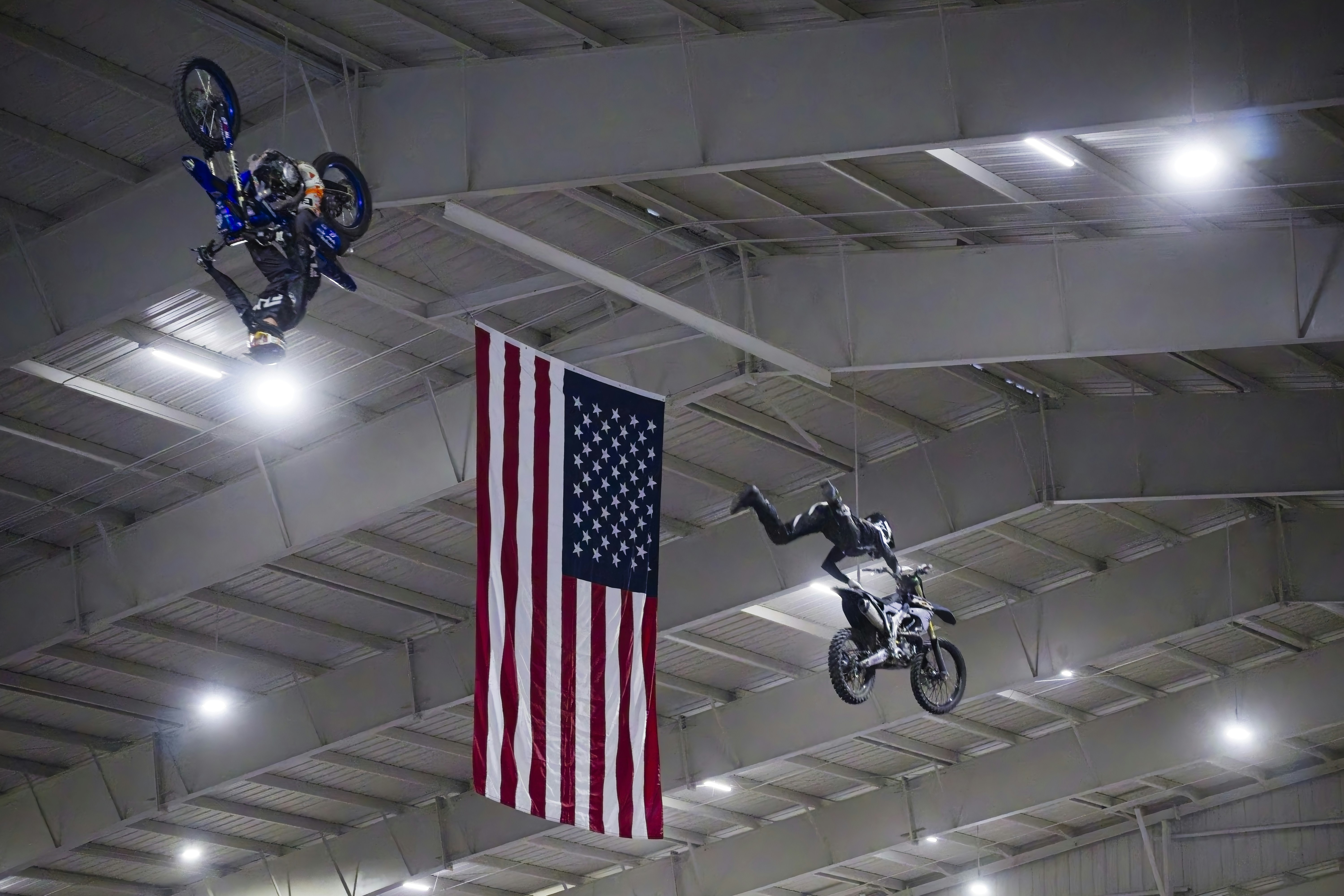 Flag and Riders Aloft: Night Arena Aerial Stunts