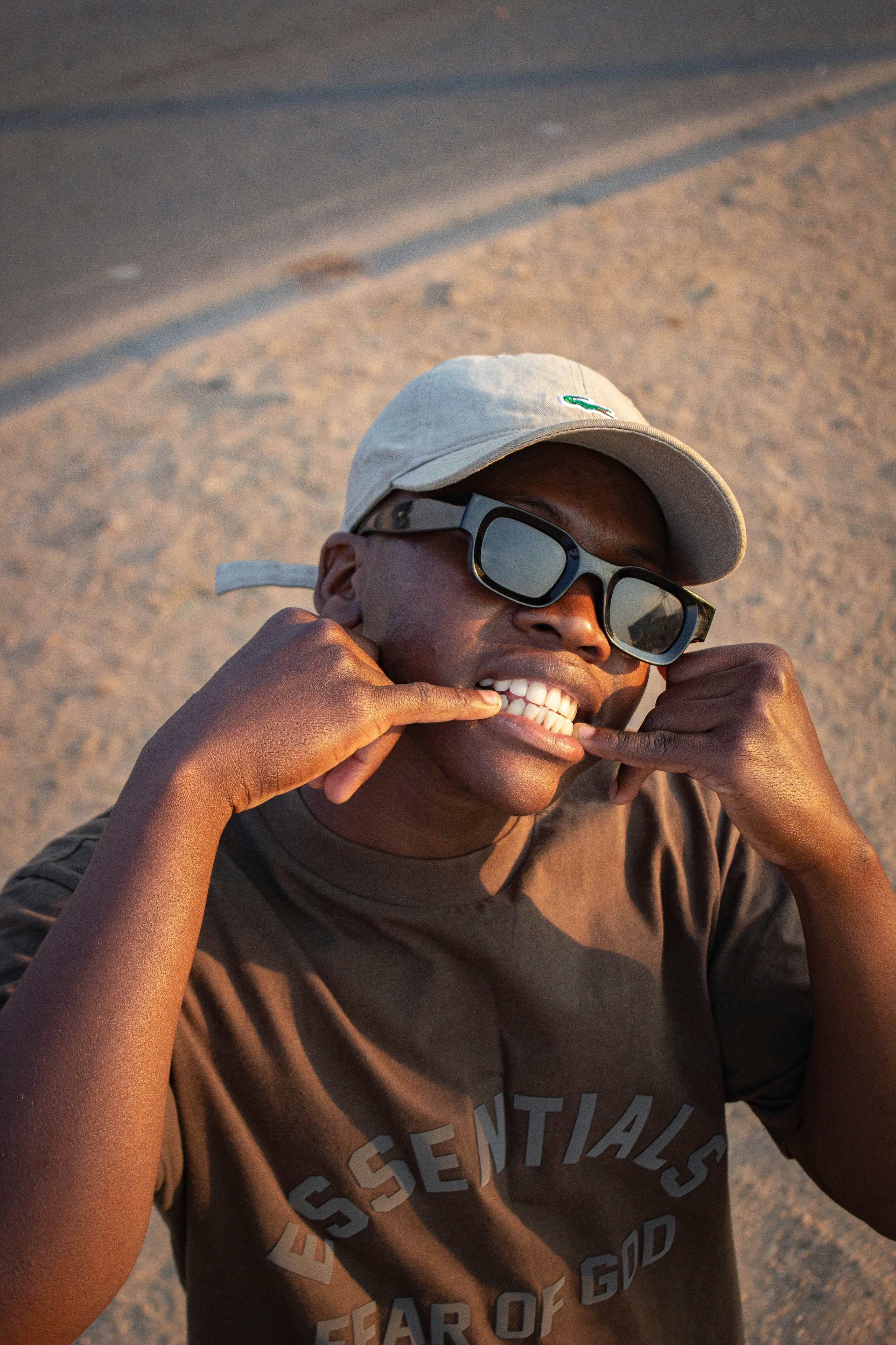 Grin Under the Sun: A Candid Moment in Warm Sand