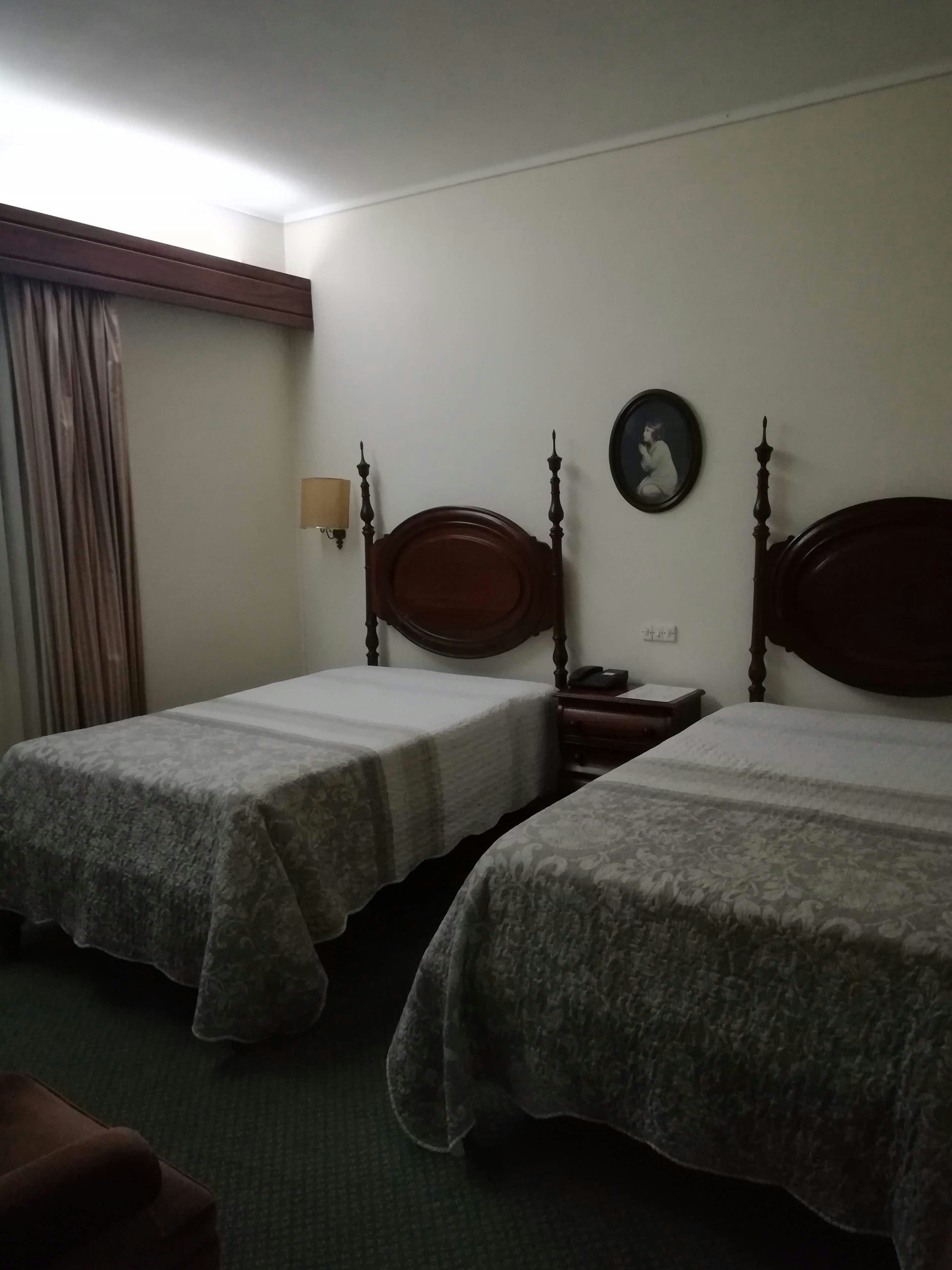 Twin Beds in a Quiet Corner: Classic Hotel Room with Symmetrical Headboards