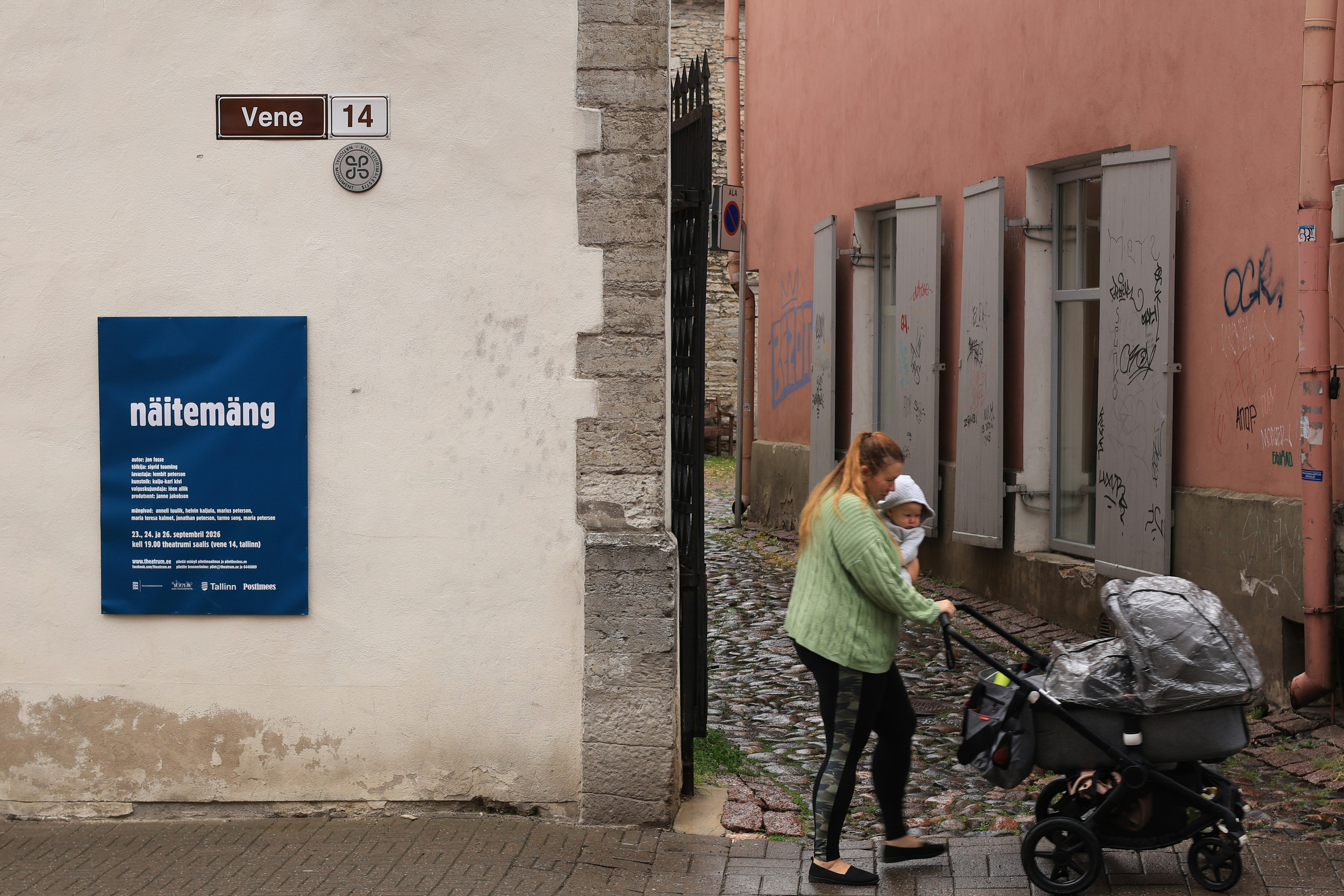 Mum with stroller on a quiet cobblestone alley
