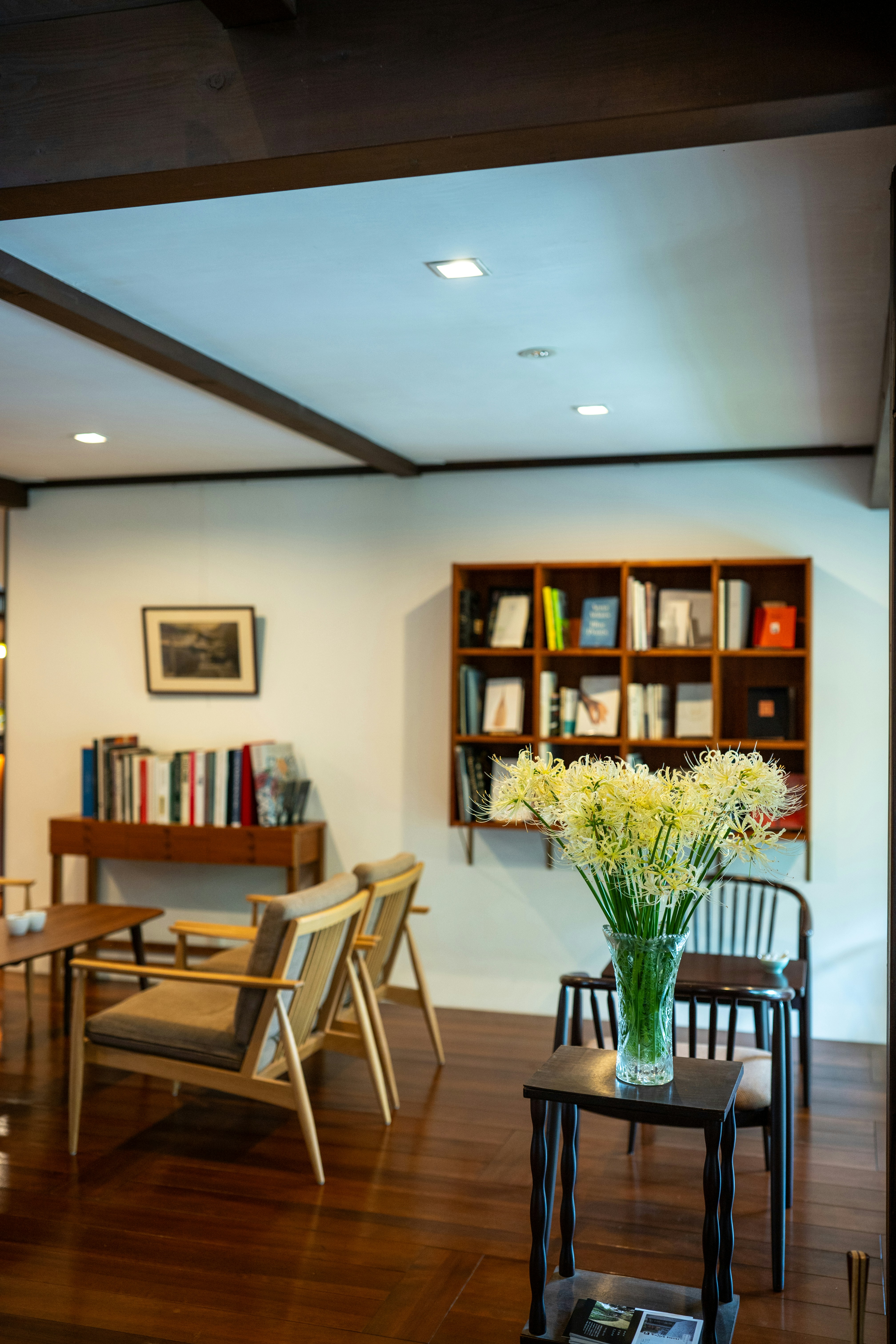 A Quiet Corner: Fresh Flowers and Warm Light in a Cozy Library