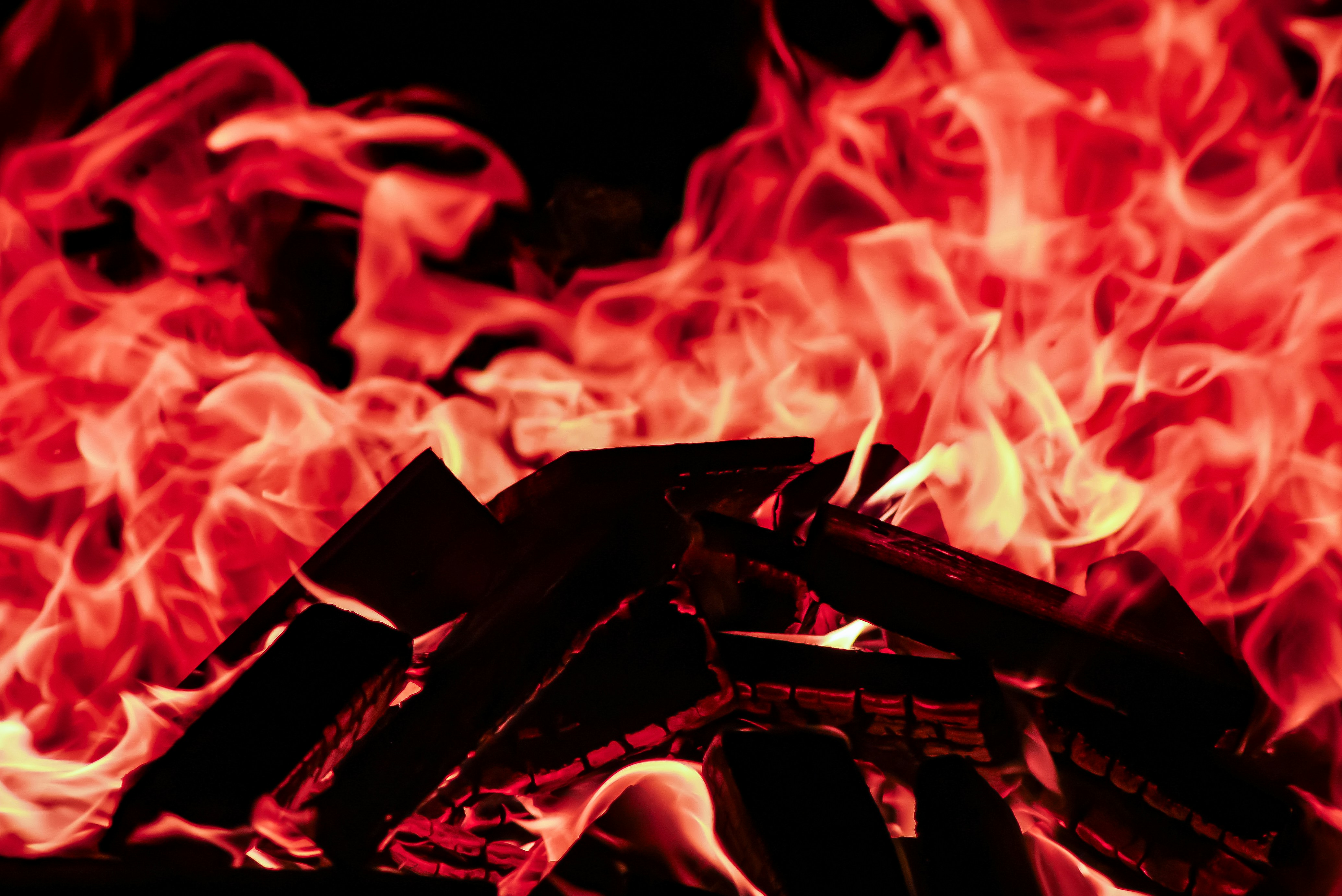 Embers in Darkness: A Flame-Licked Stack of Charcoal