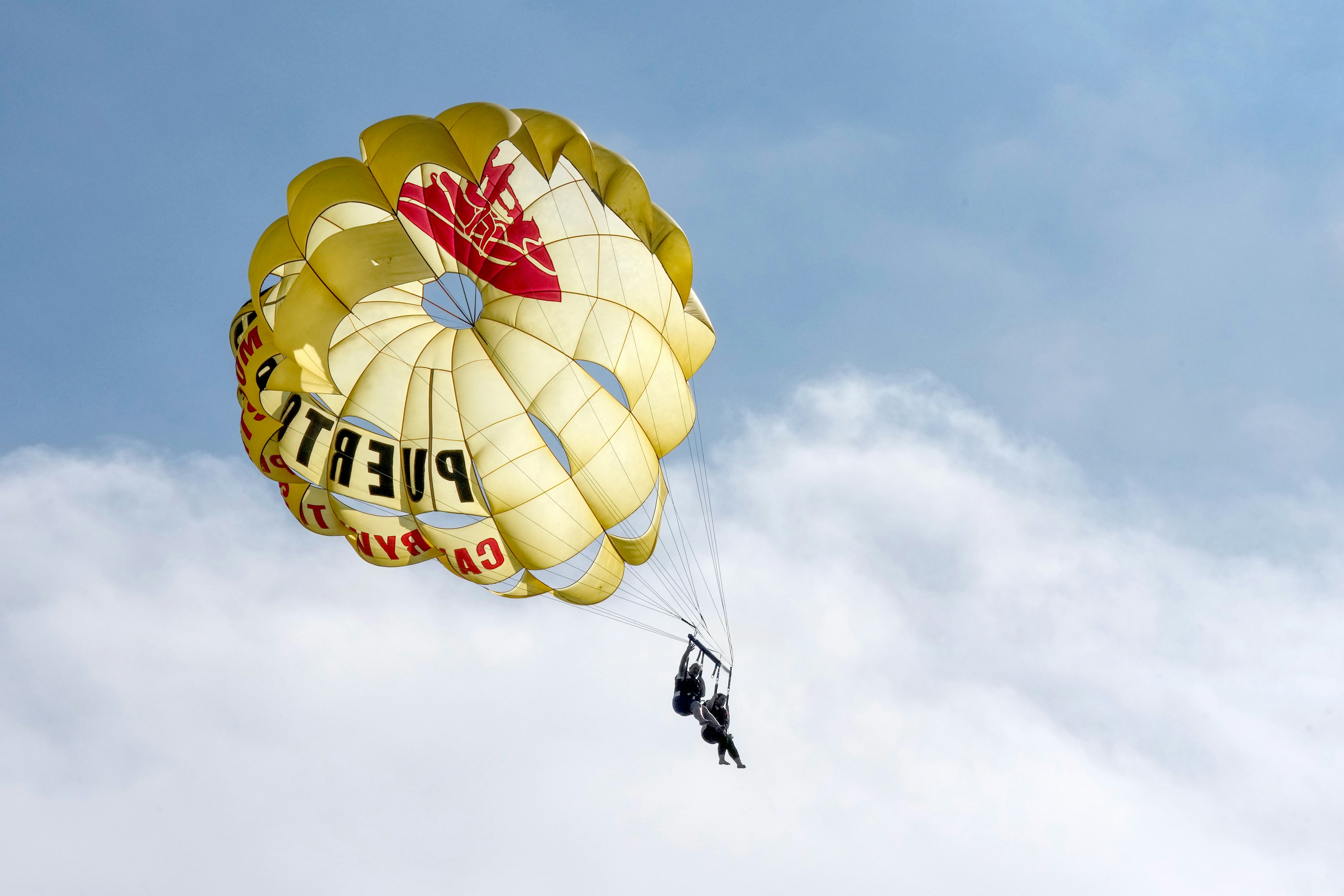 Soaring Umbrella: Parachute Duo in a Quiet Sky